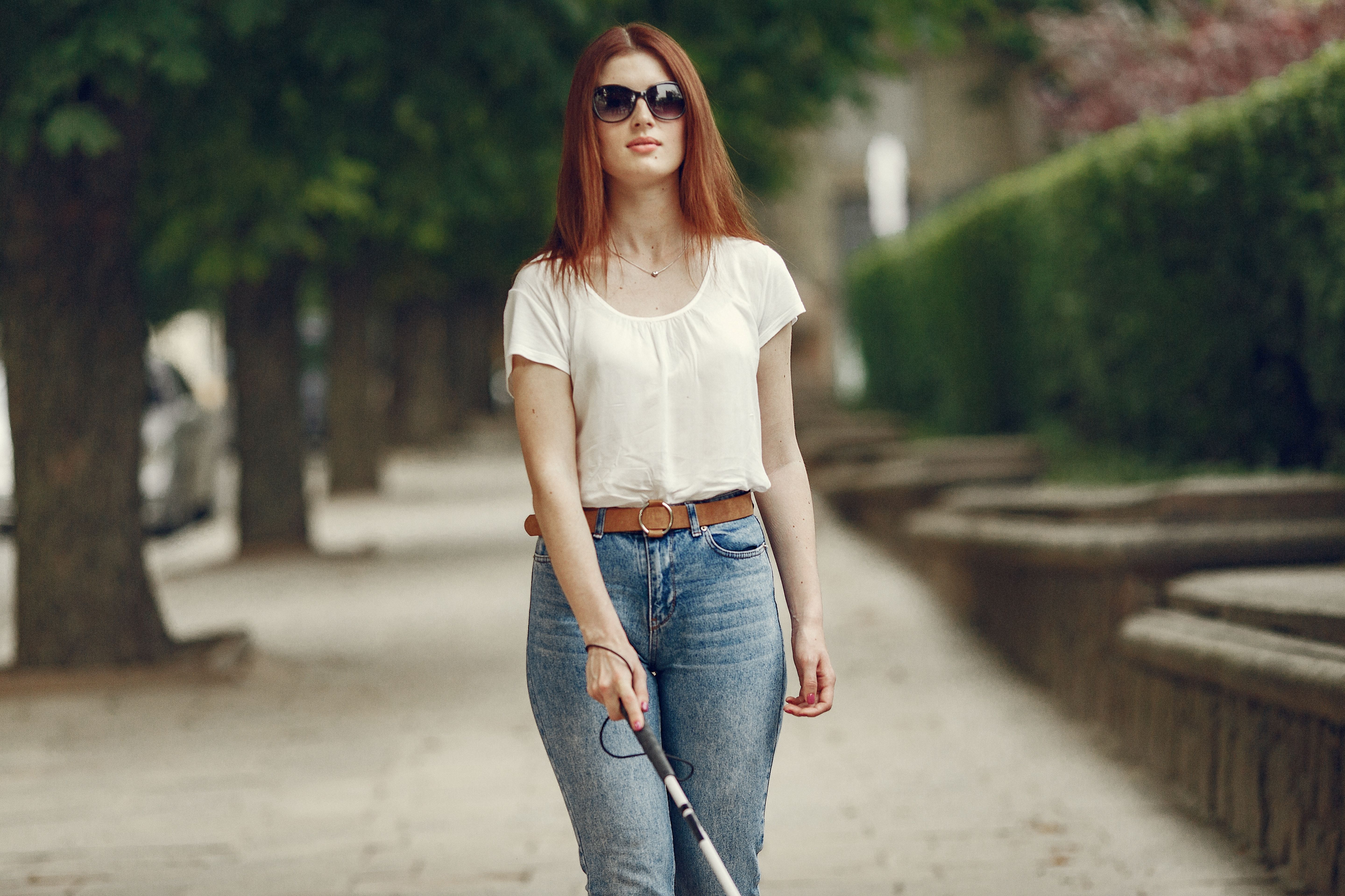 Shallow Focus of a Blind Woman Walking on the Sidewalk with Her Cane ...