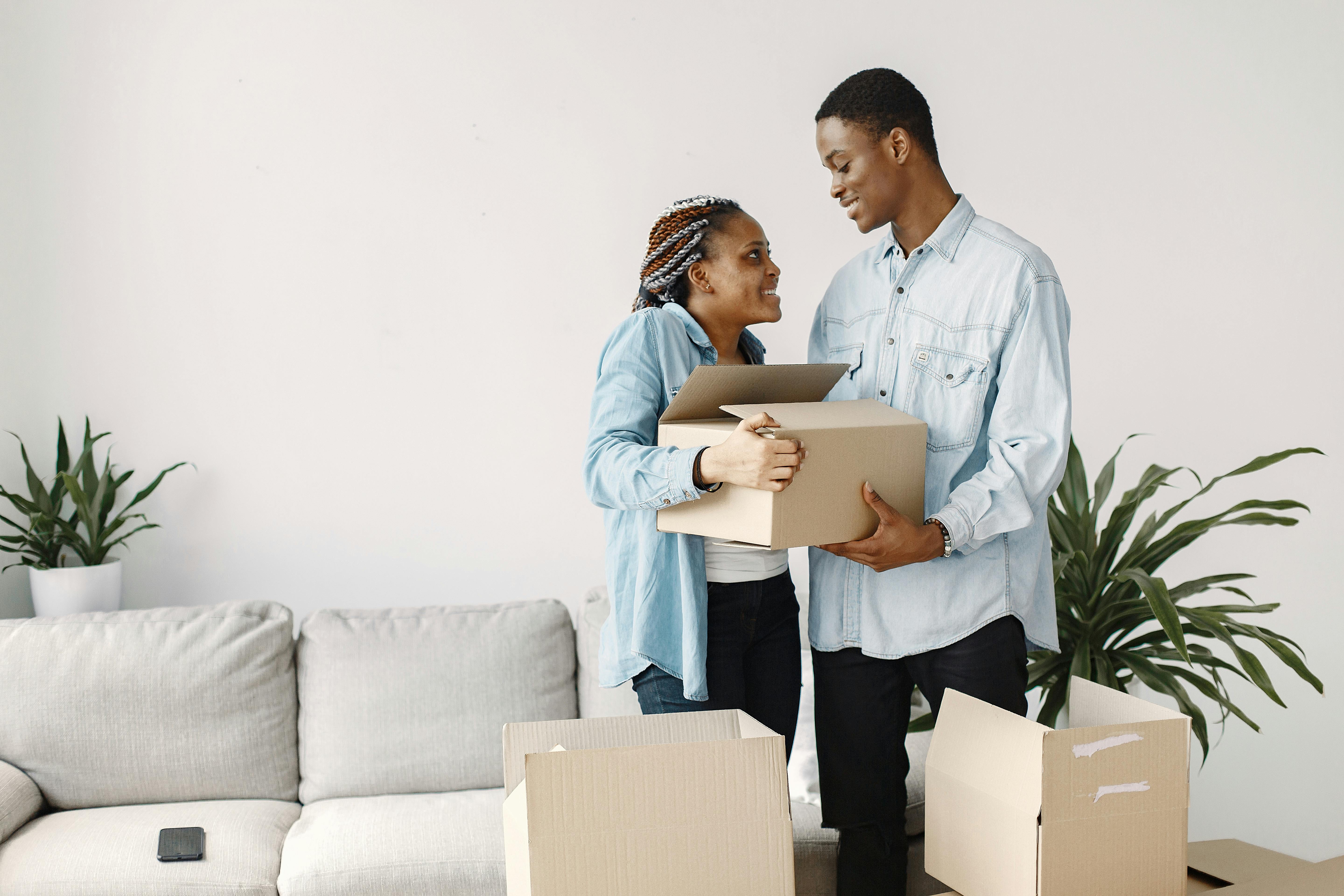 Woman In Grey Shirt Holding Brown Cardboard Box · Free Stock Photo