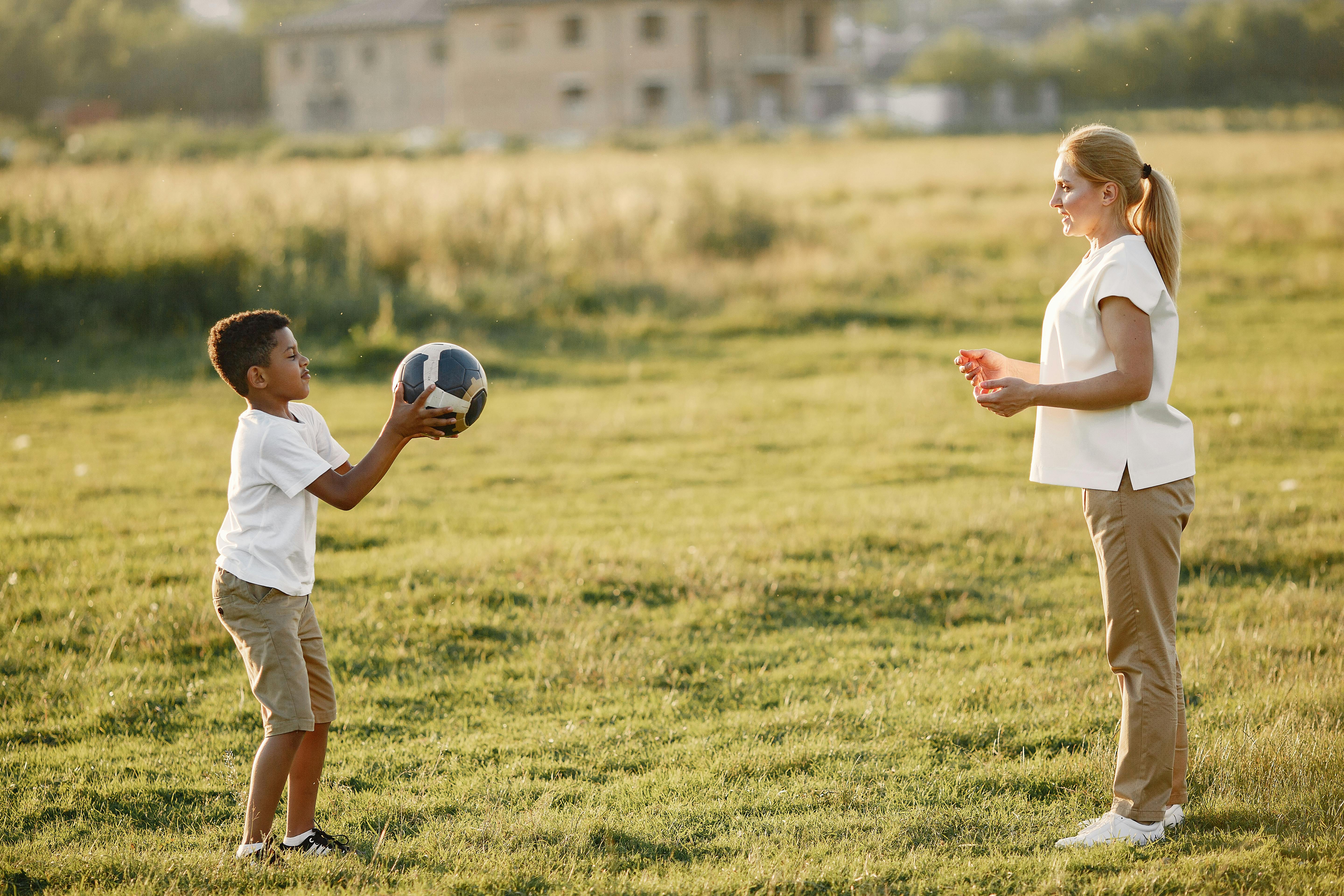 Woman and Boy Playing Ball Together · Free Stock Photo