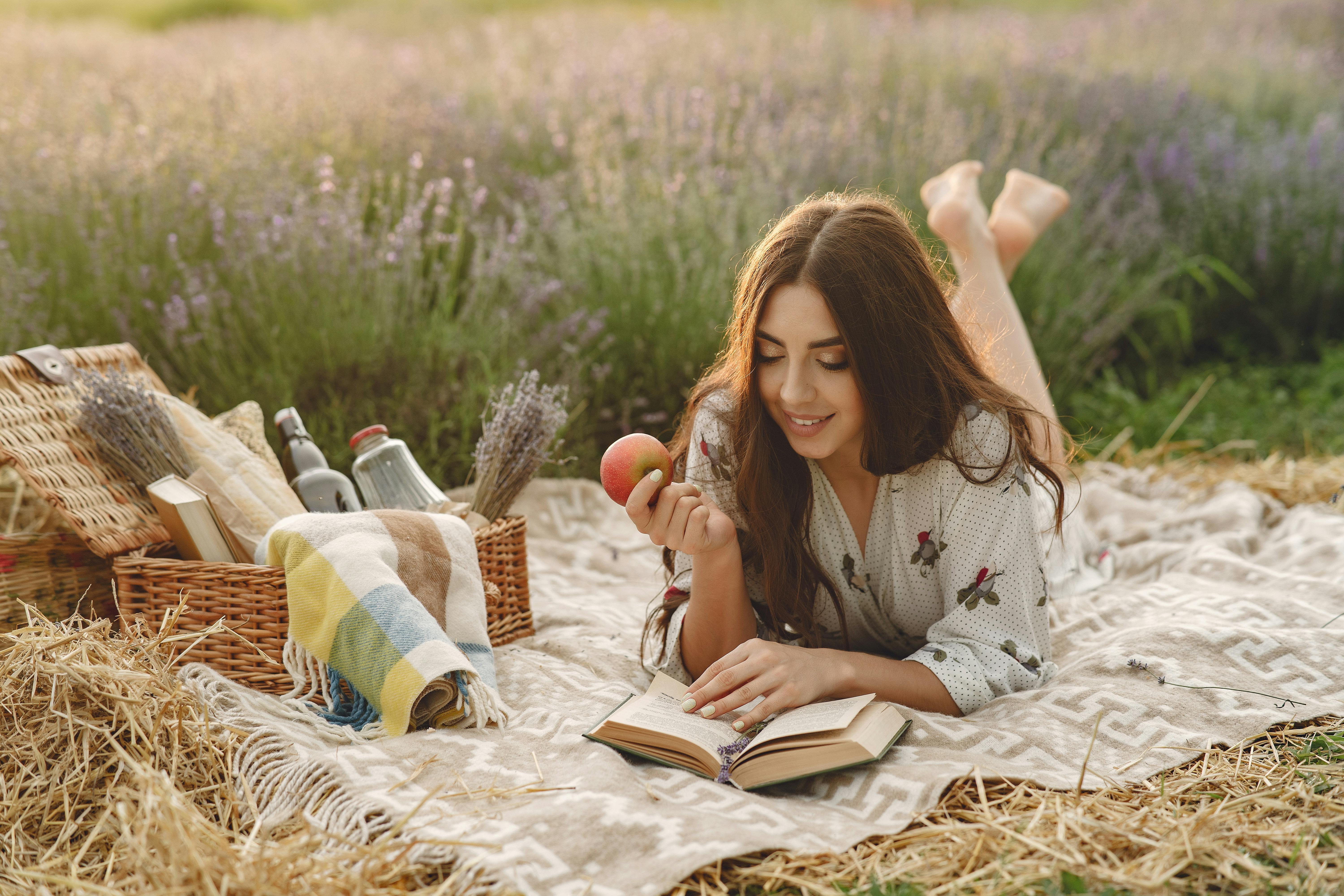 Relaxed Woman Reading on Picnic Blanket · Free Stock Photo