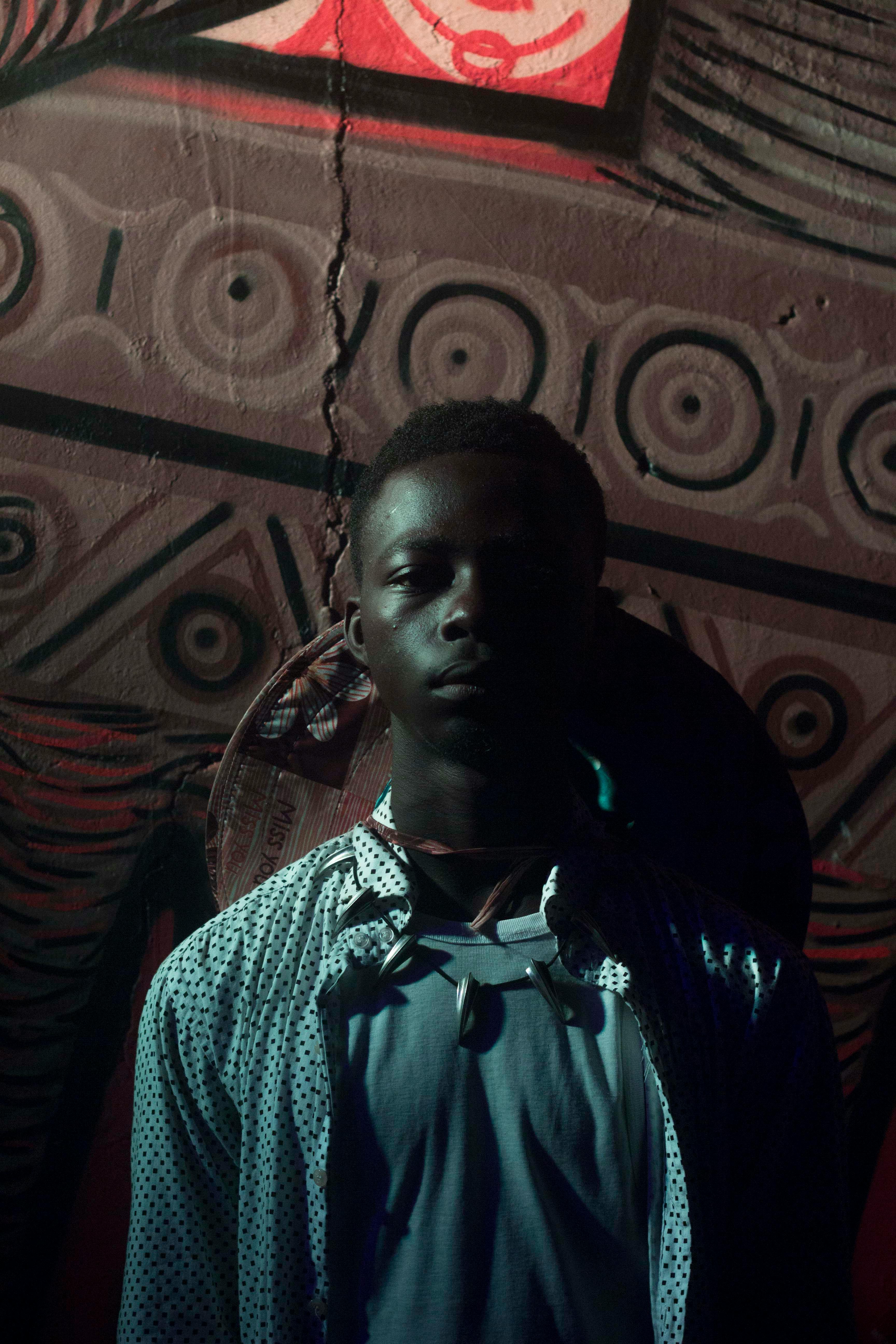 Teenage Boy in Shadow and with Graffiti behind · Free Stock Photo