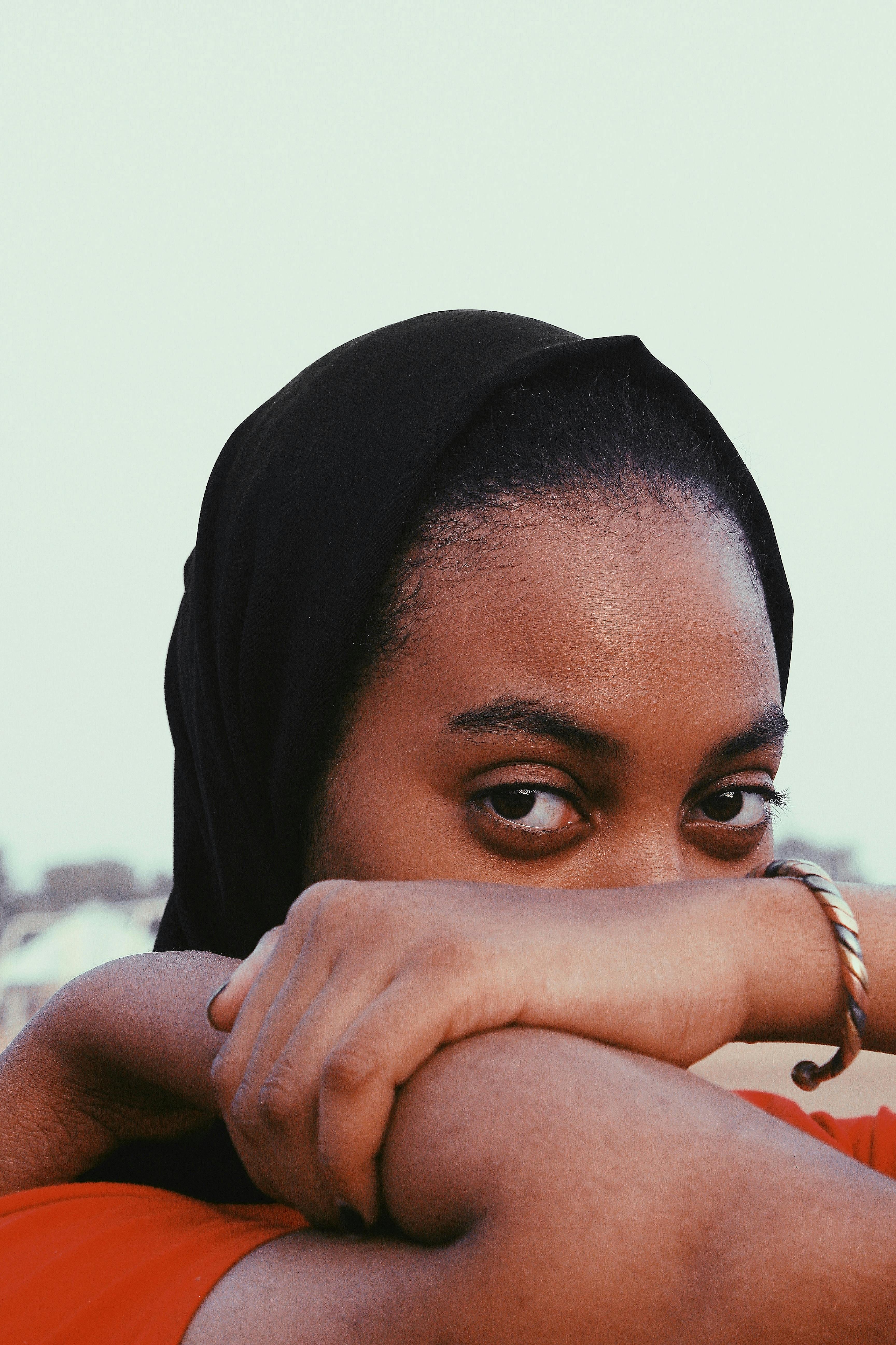 Black woman covering face with hand · Free Stock Photo