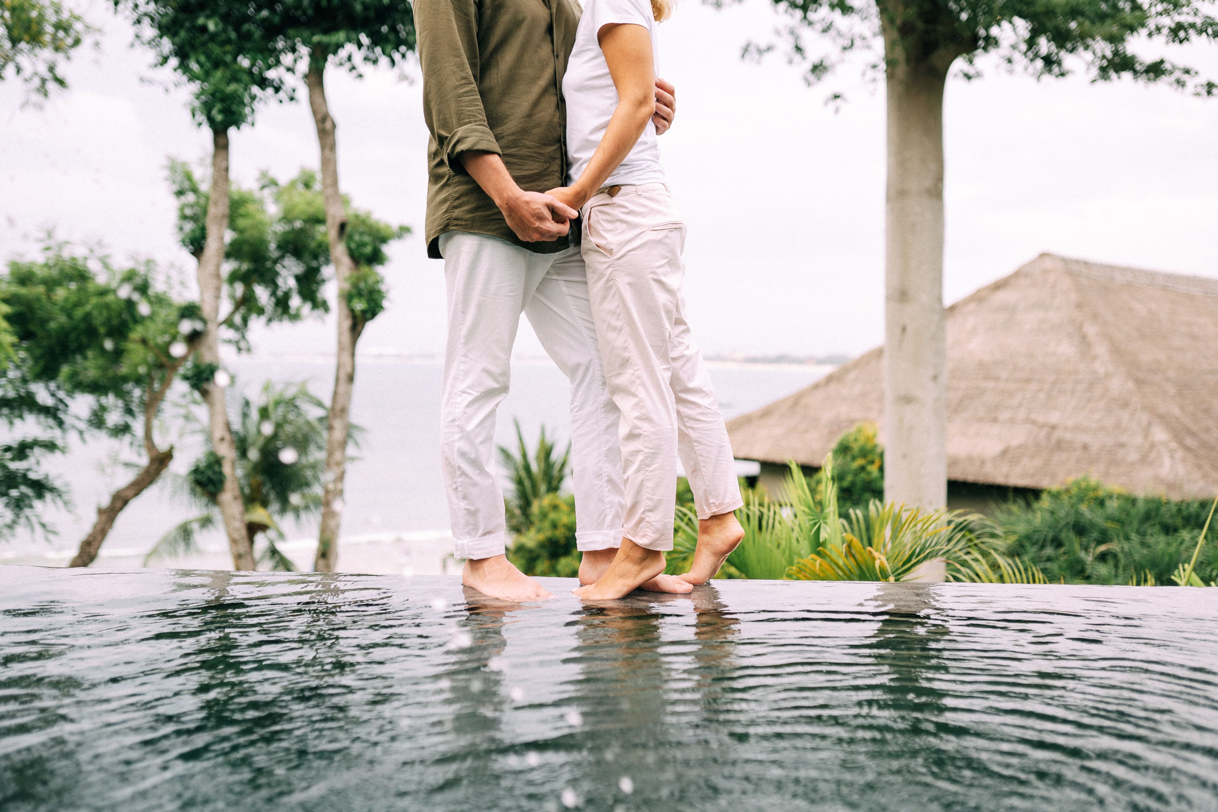 Wet Couple Sitting under Waterfall · Free Stock Photo