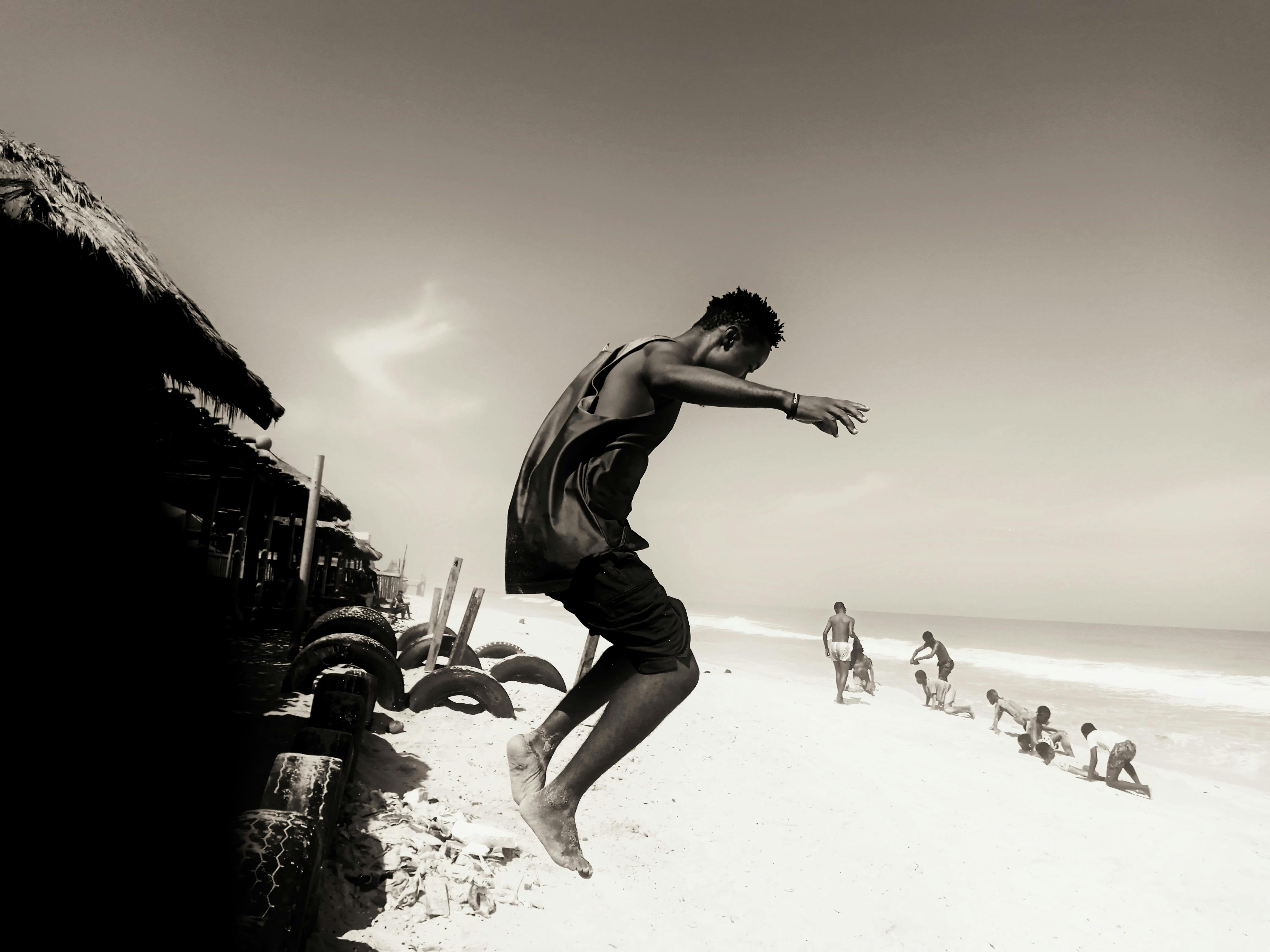 Black and White Photo of a Man in Jumping Motion · Free Stock Photo