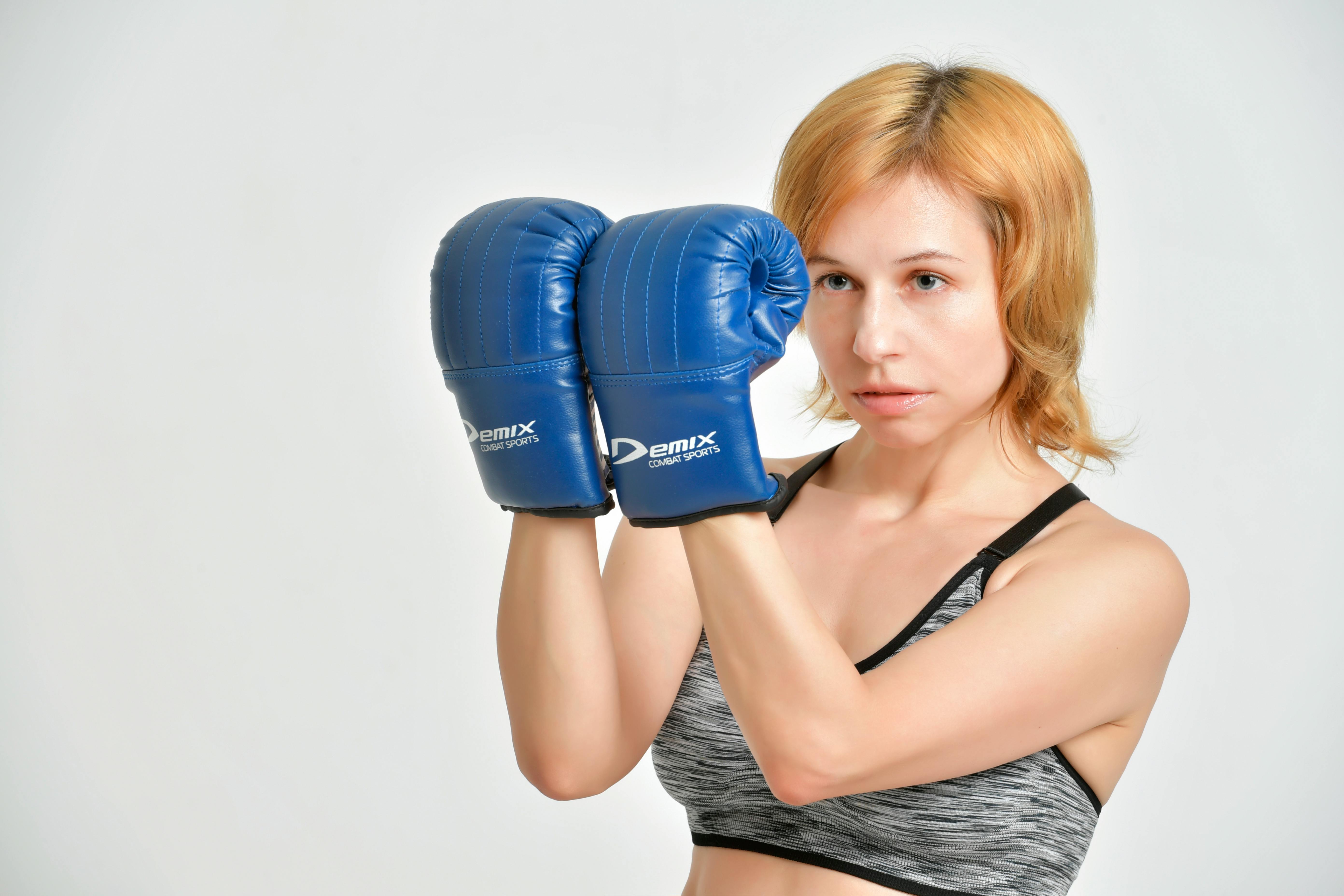 Confident female boxer leaning on shelves · Free Stock Photo