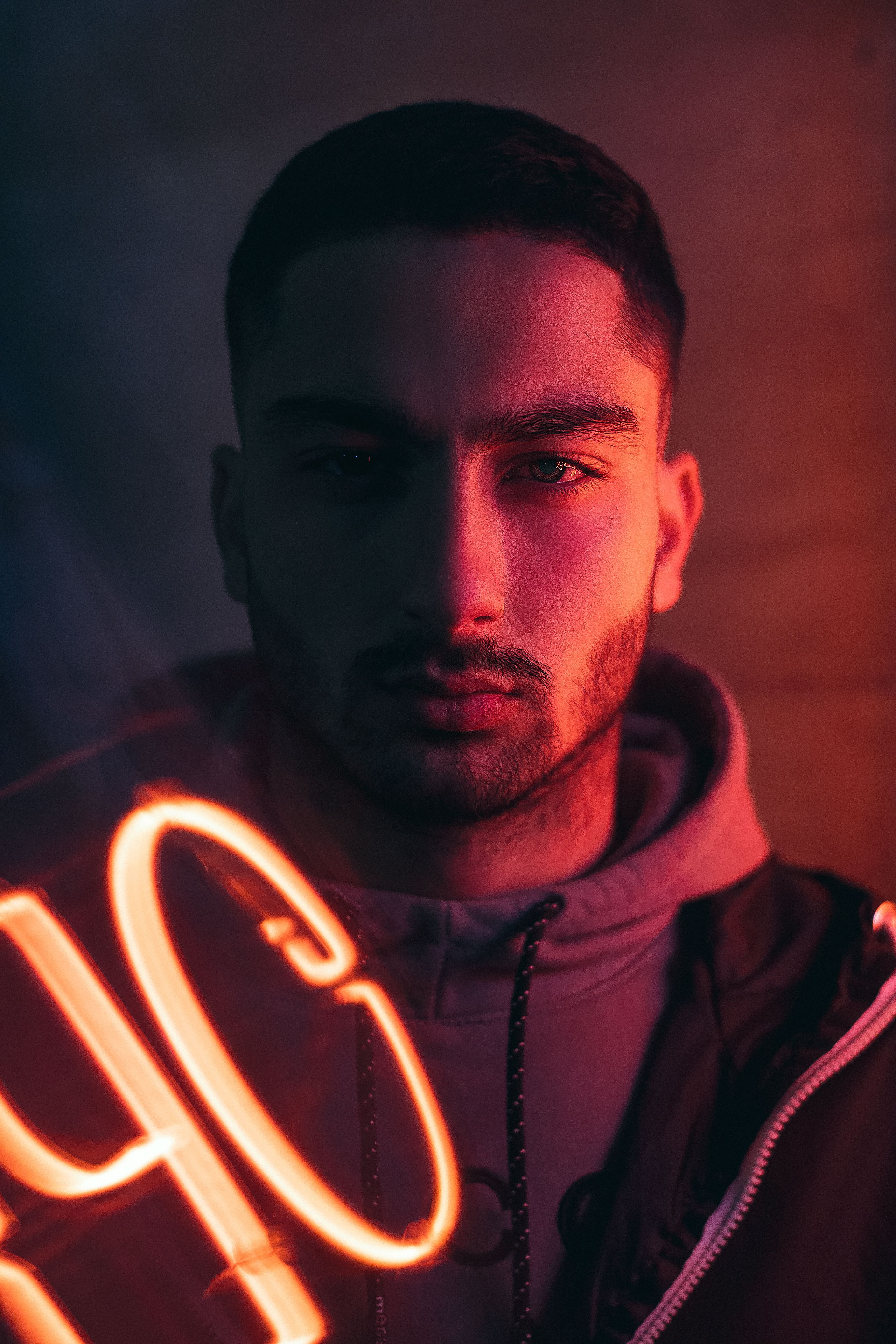 A Man Posing Near Neon Lights · Free Stock Photo
