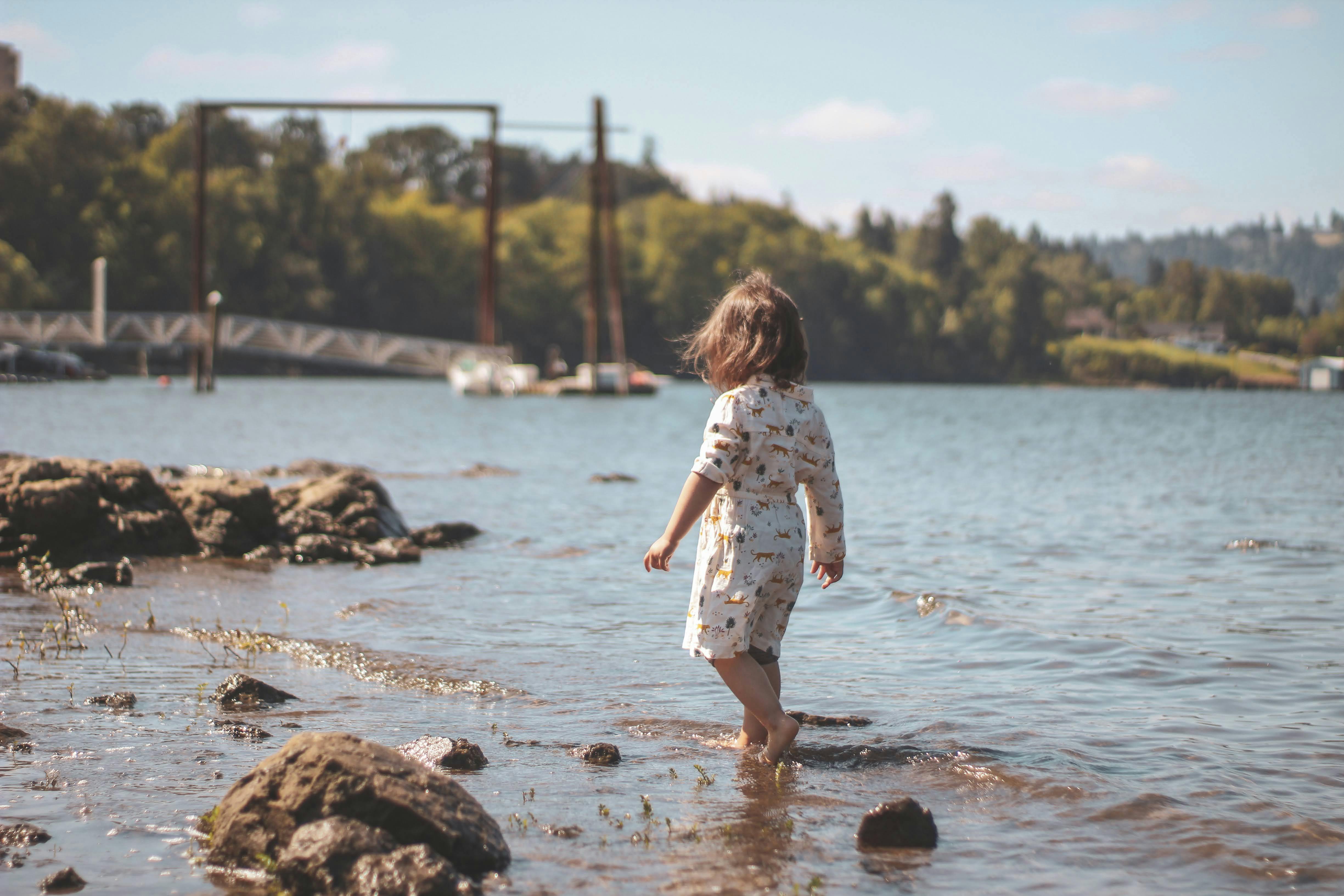 A Young Girl Playing on the River · Free Stock Photo