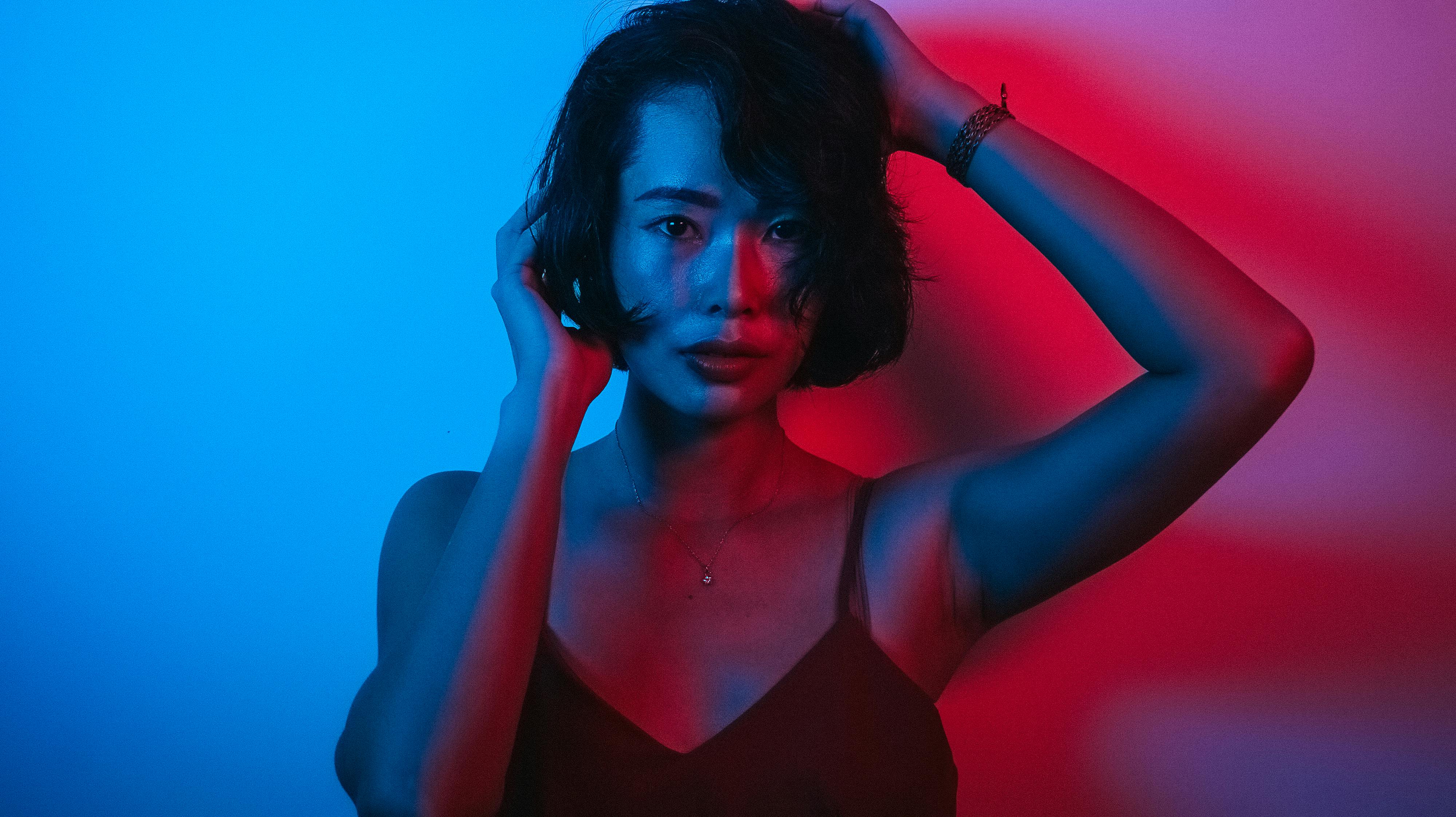 A Woman Posing in Blue and Red Light · Free Stock Photo