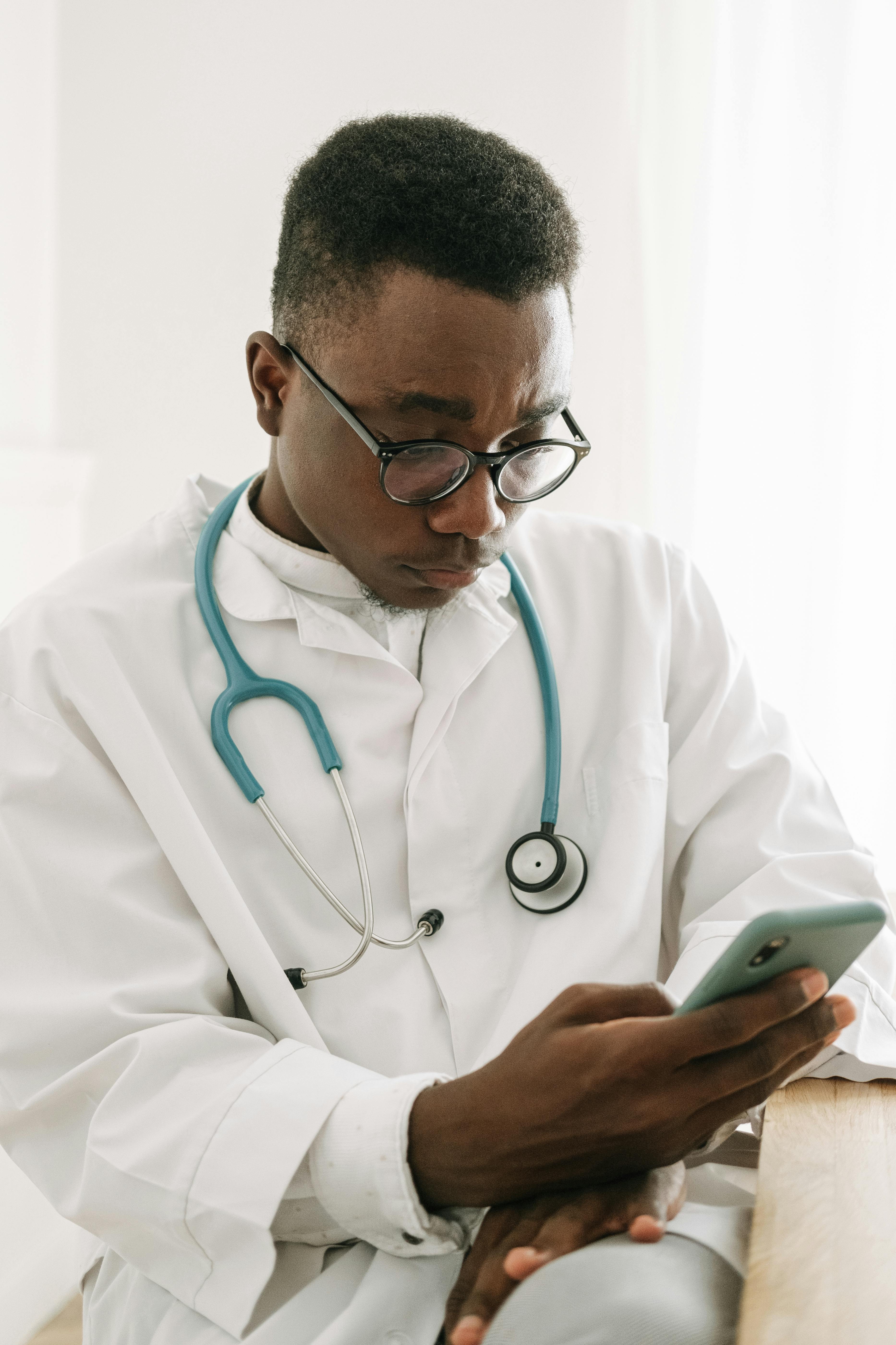 A Doctor Using a Smartphone · Free Stock Photo