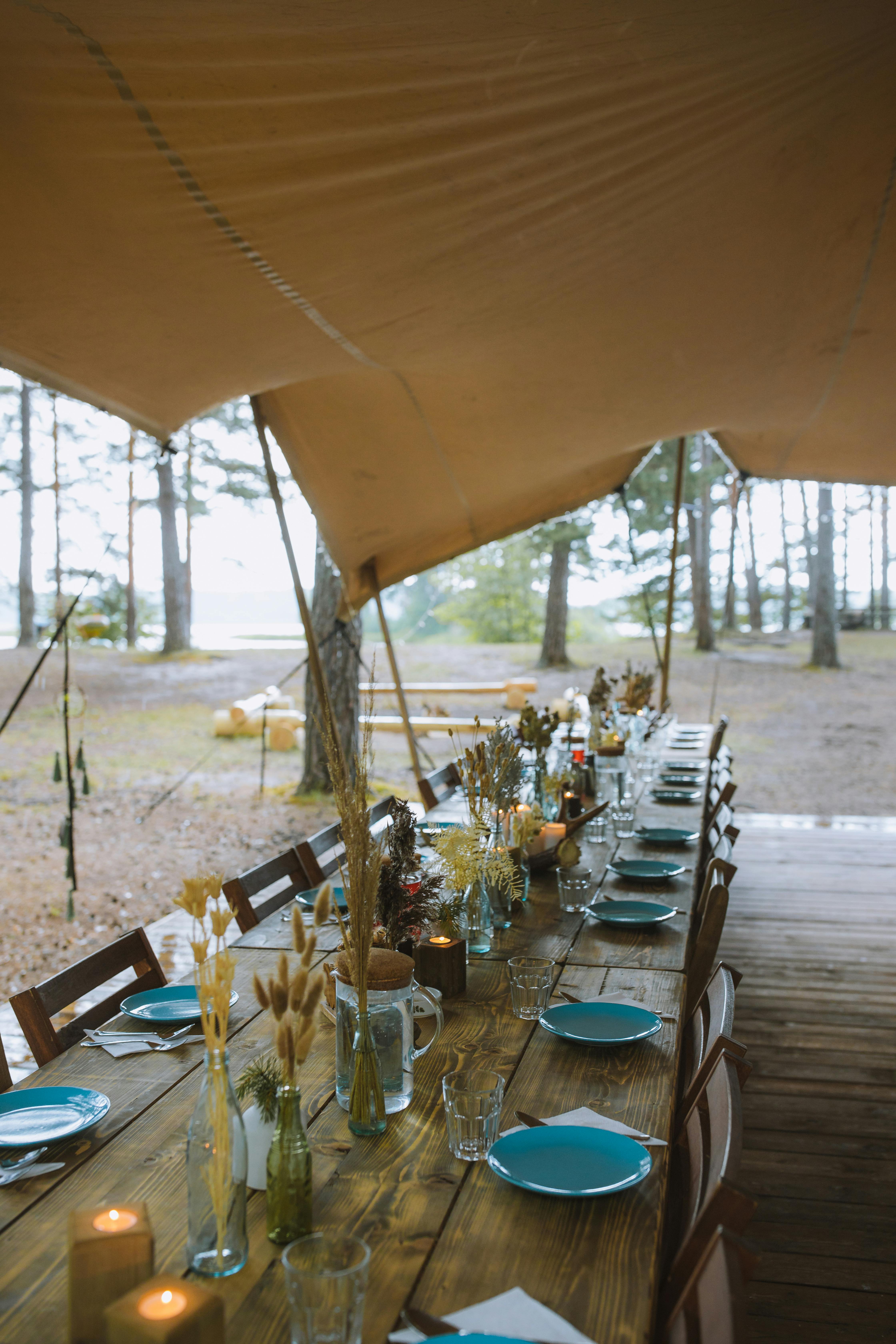 A Long Dining Table Under a Canopy · Free Stock Photo