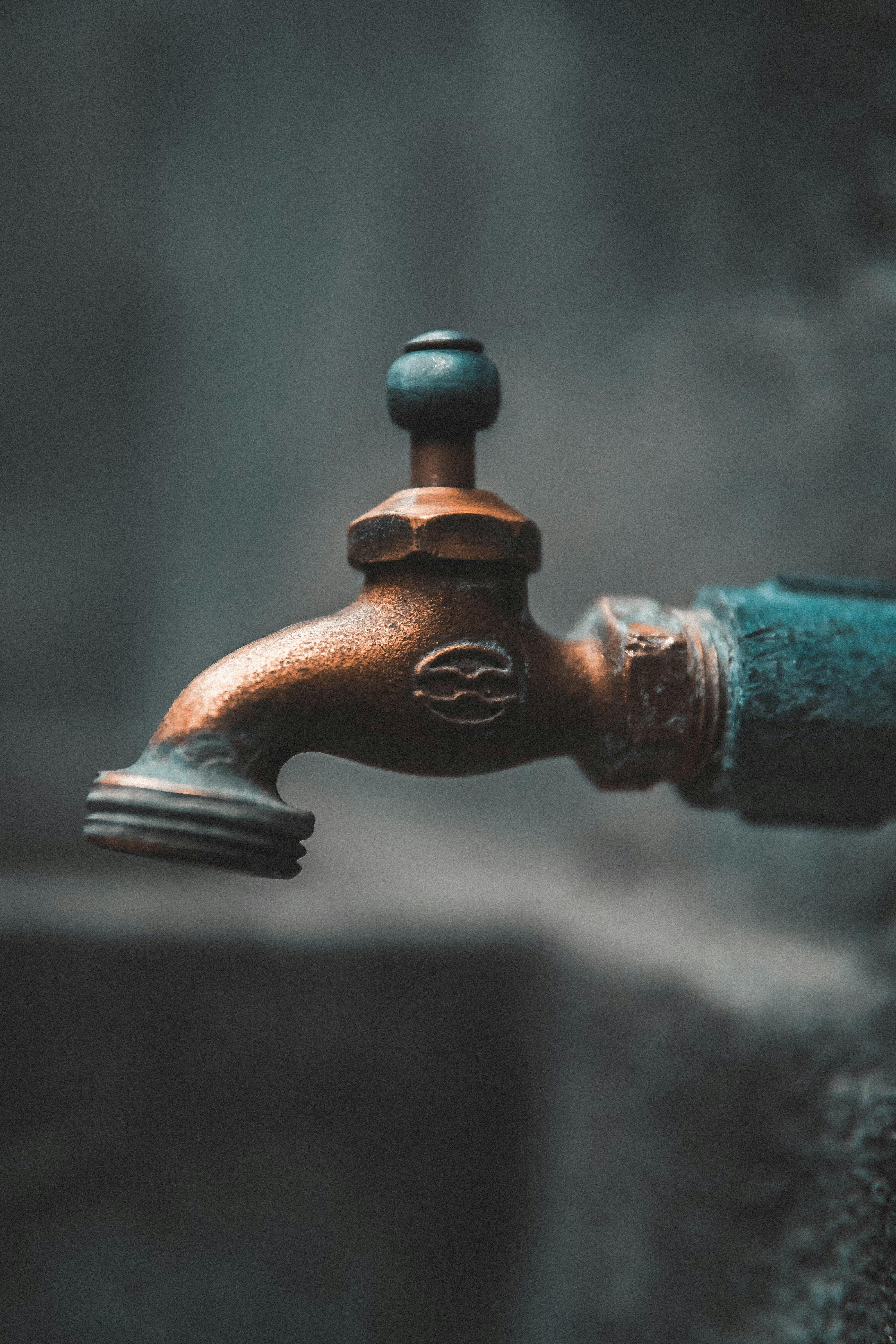 Close-Up Shot of a Metal Faucet · Free Stock Photo