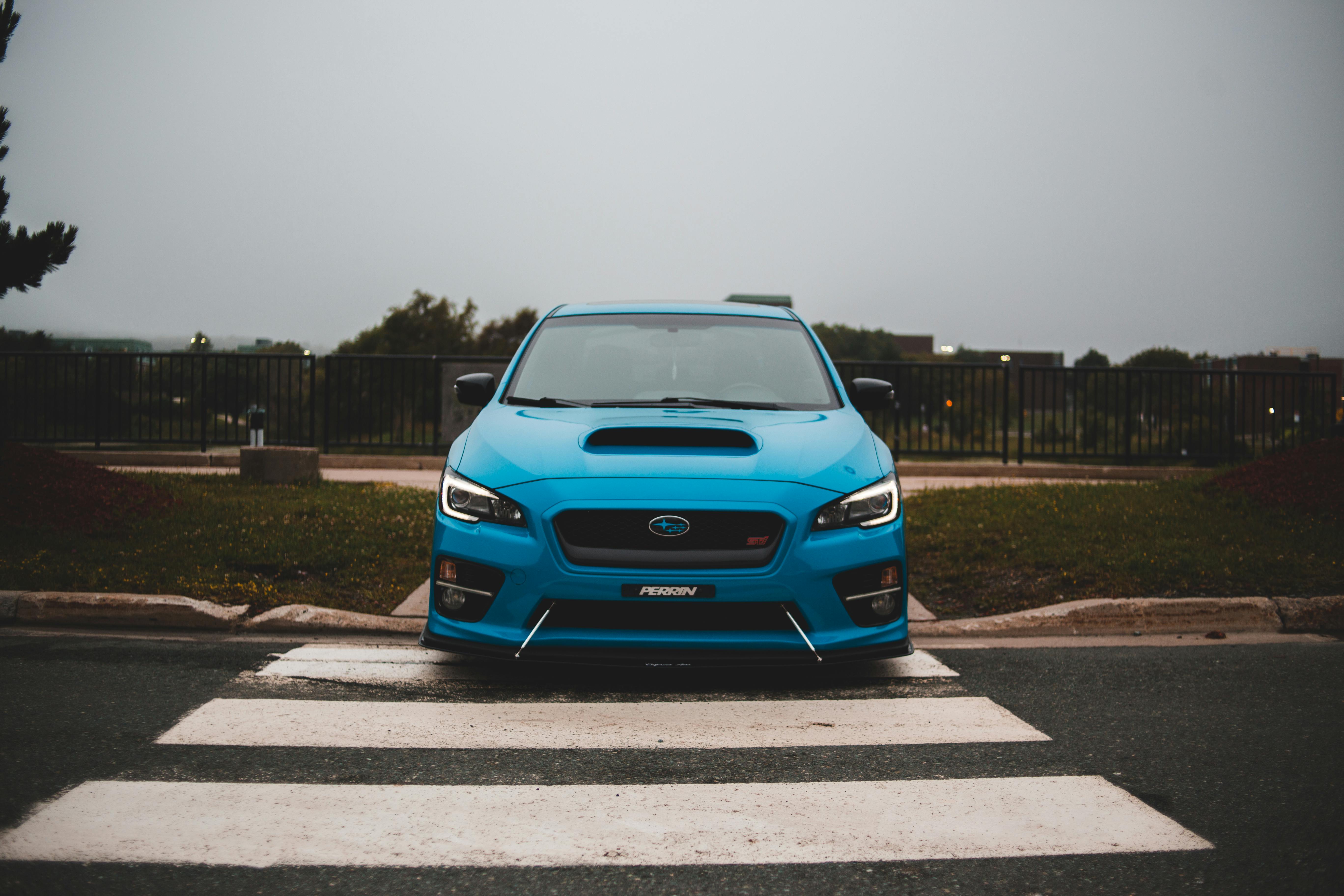 Bright blue sport car with sparkling headlights · Free Stock Photo