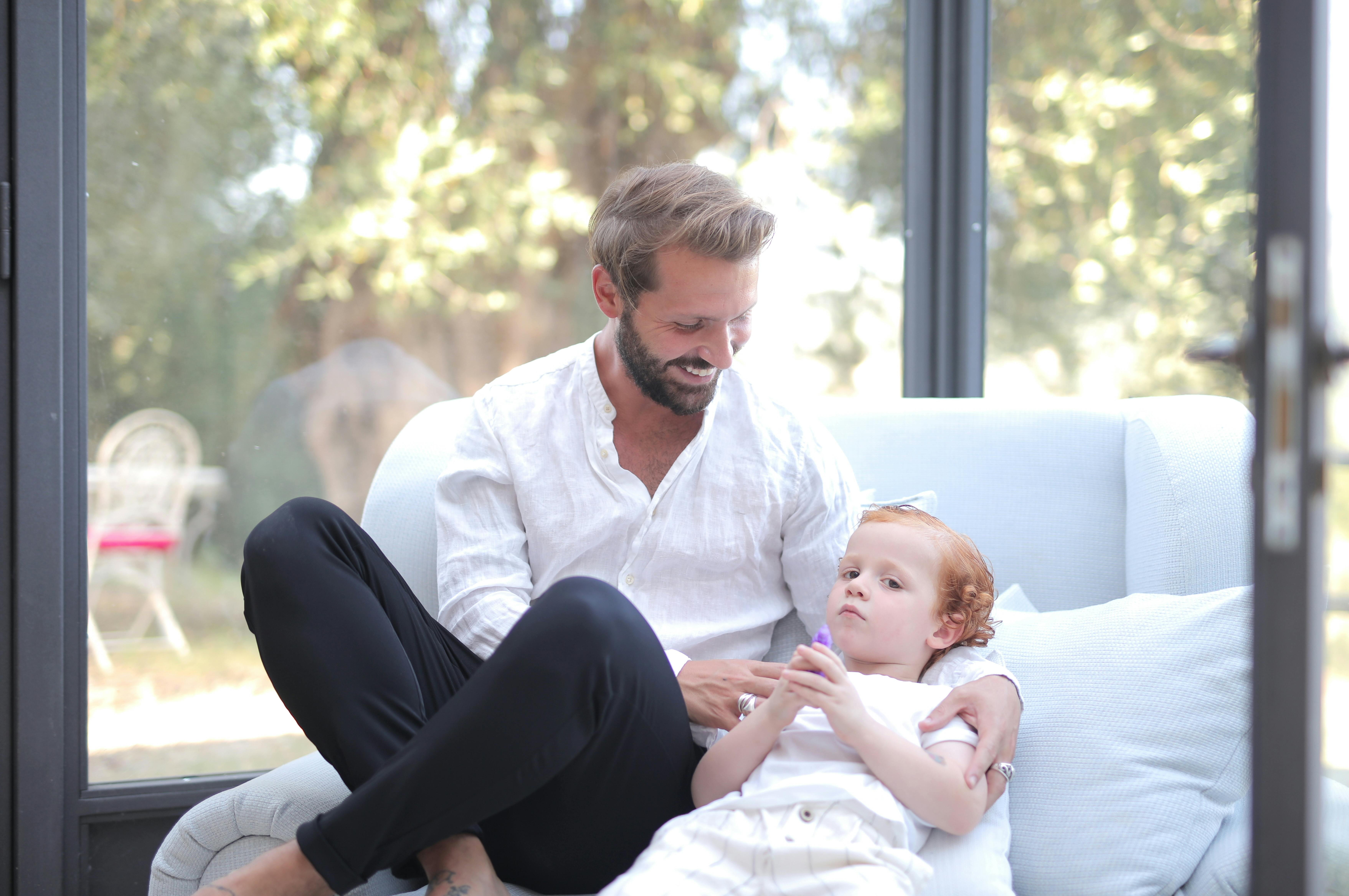 Father and Daughter Sitting on Sofa Chair · Free Stock Photo