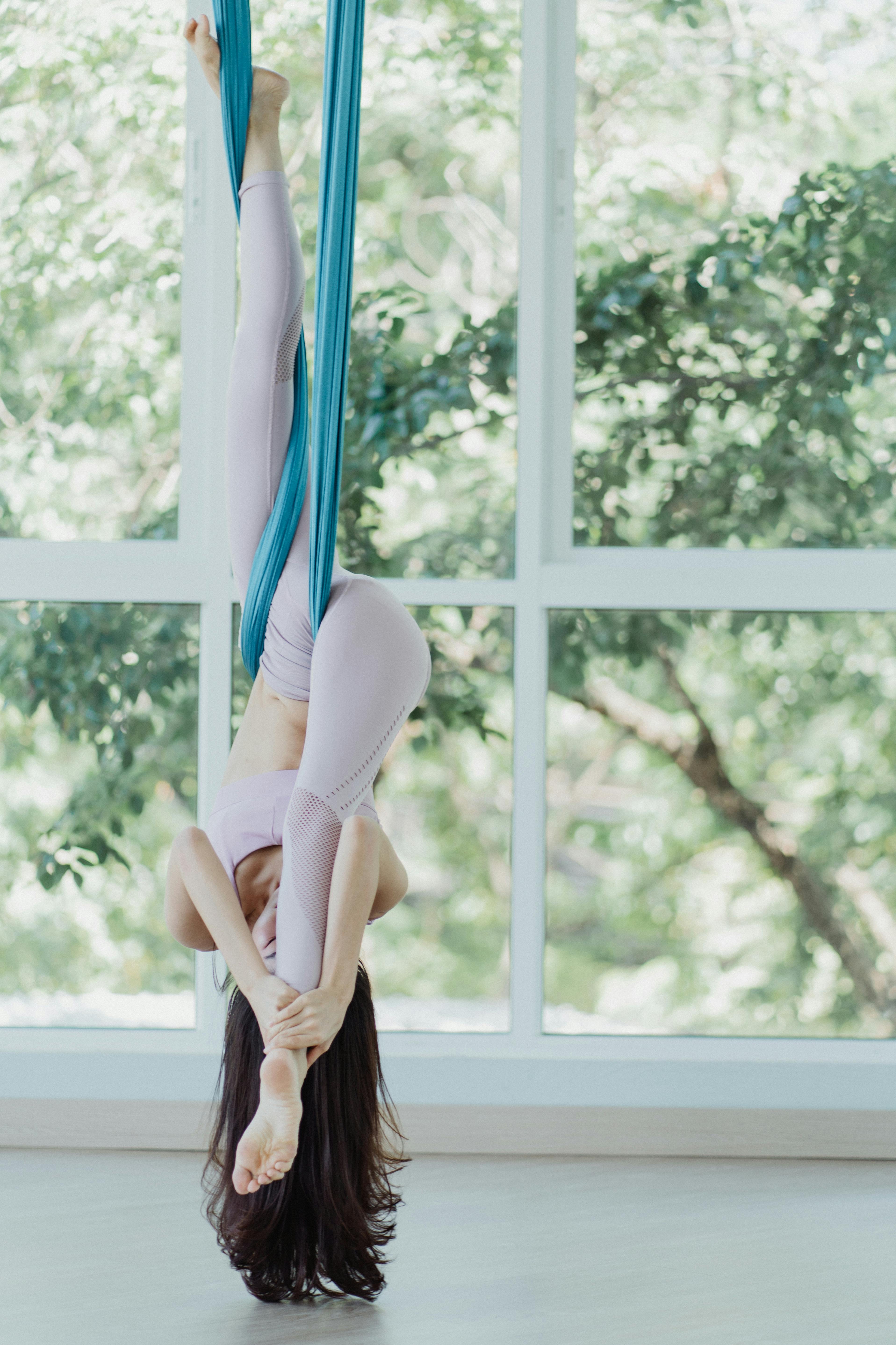 A Woman Doing Leg Splits While Hanging by the Fabric · Free Stock Photo