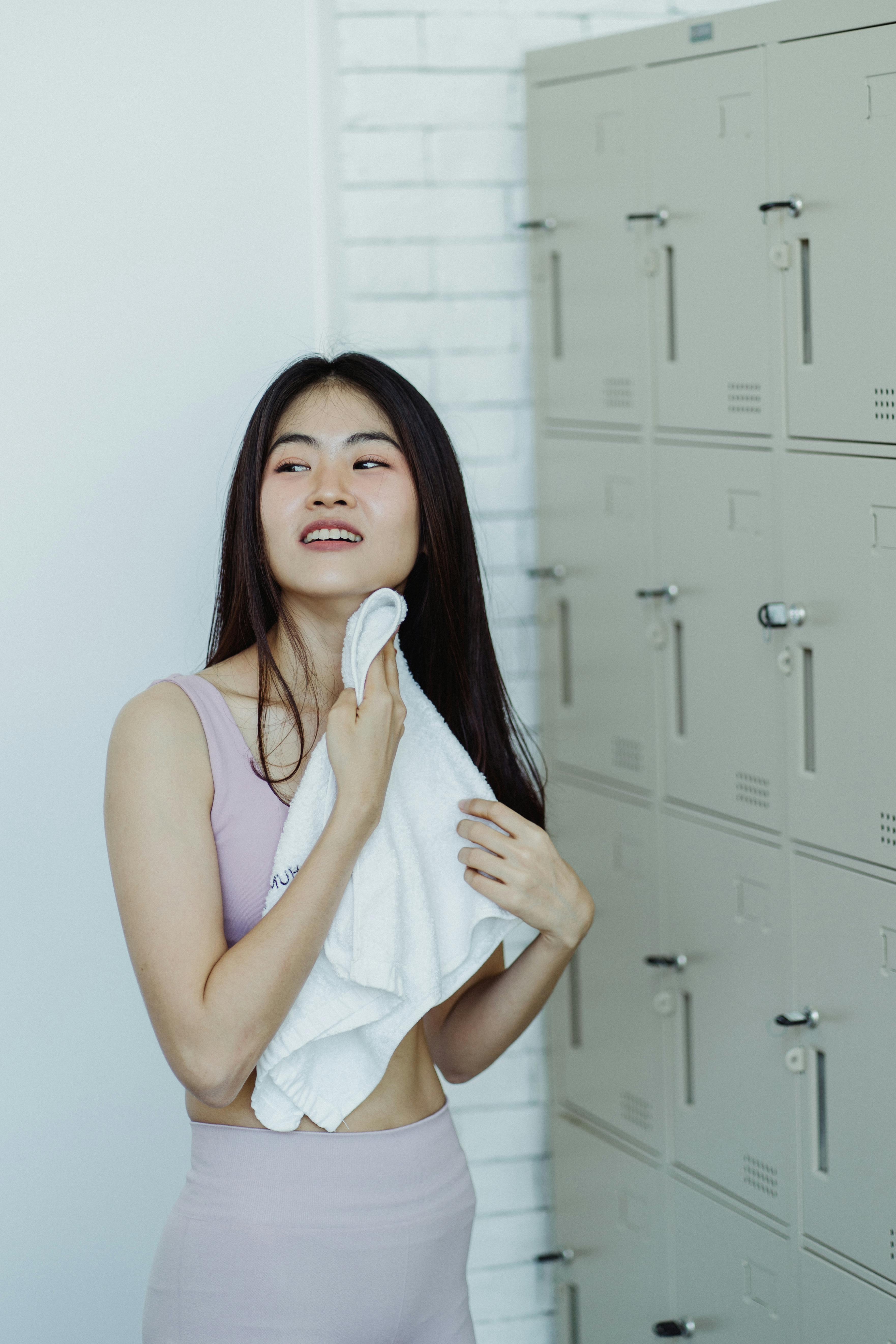 Woman Wiping Herself after Exercising · Free Stock Photo