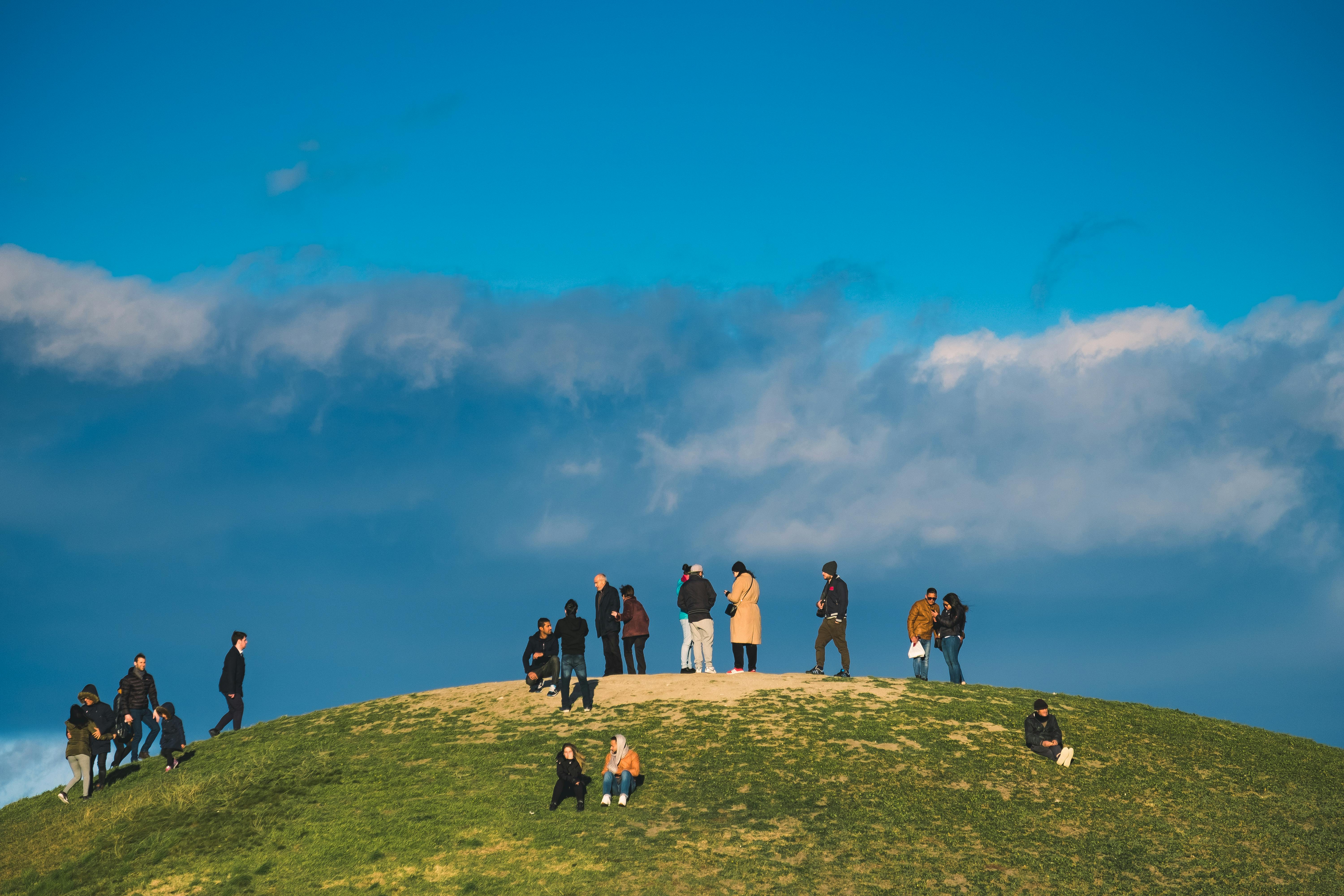 People on Green Grass Field Under Blue Sky · Free Stock Photo