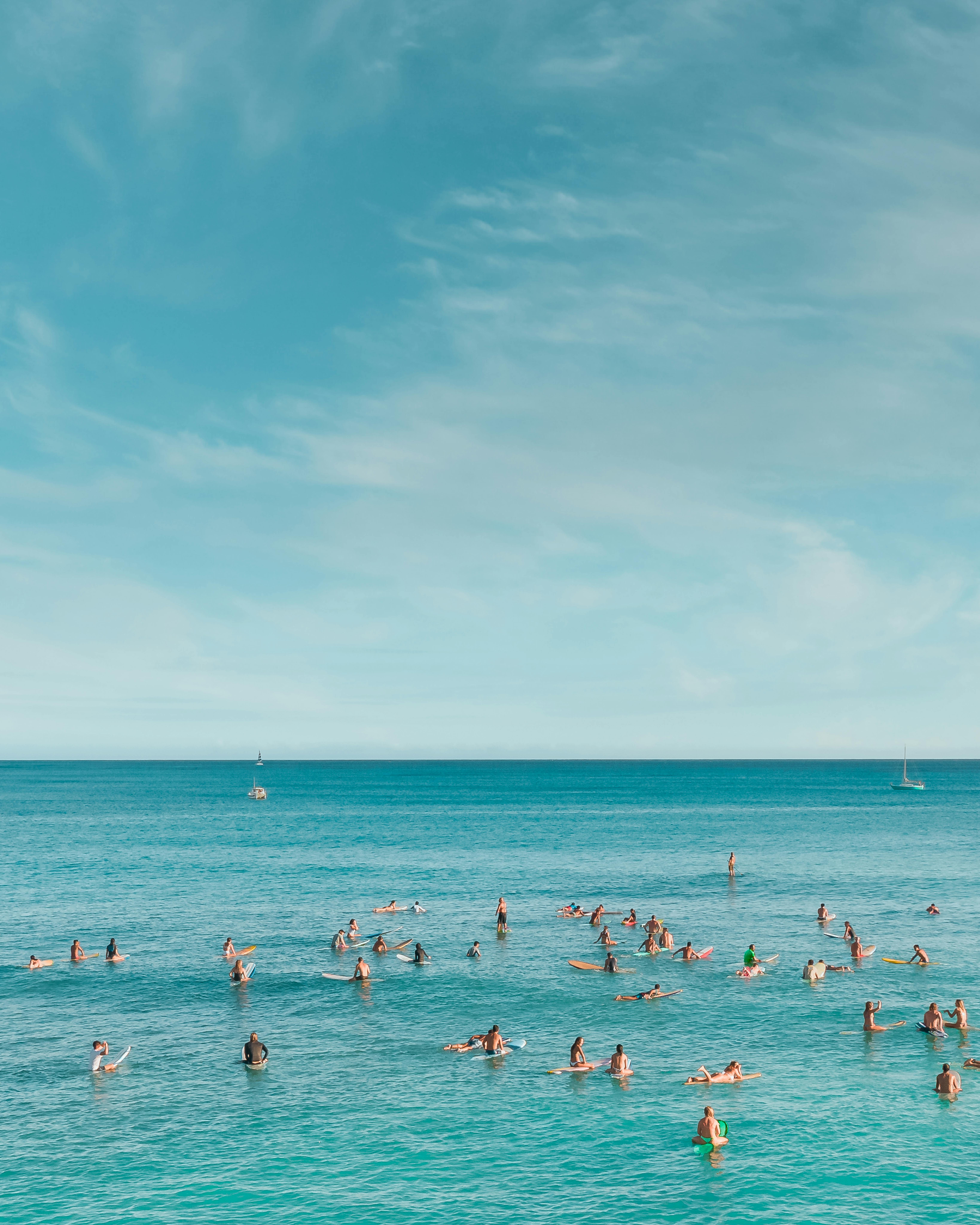 Photograph of People Surfing at the Beach · Free Stock Photo