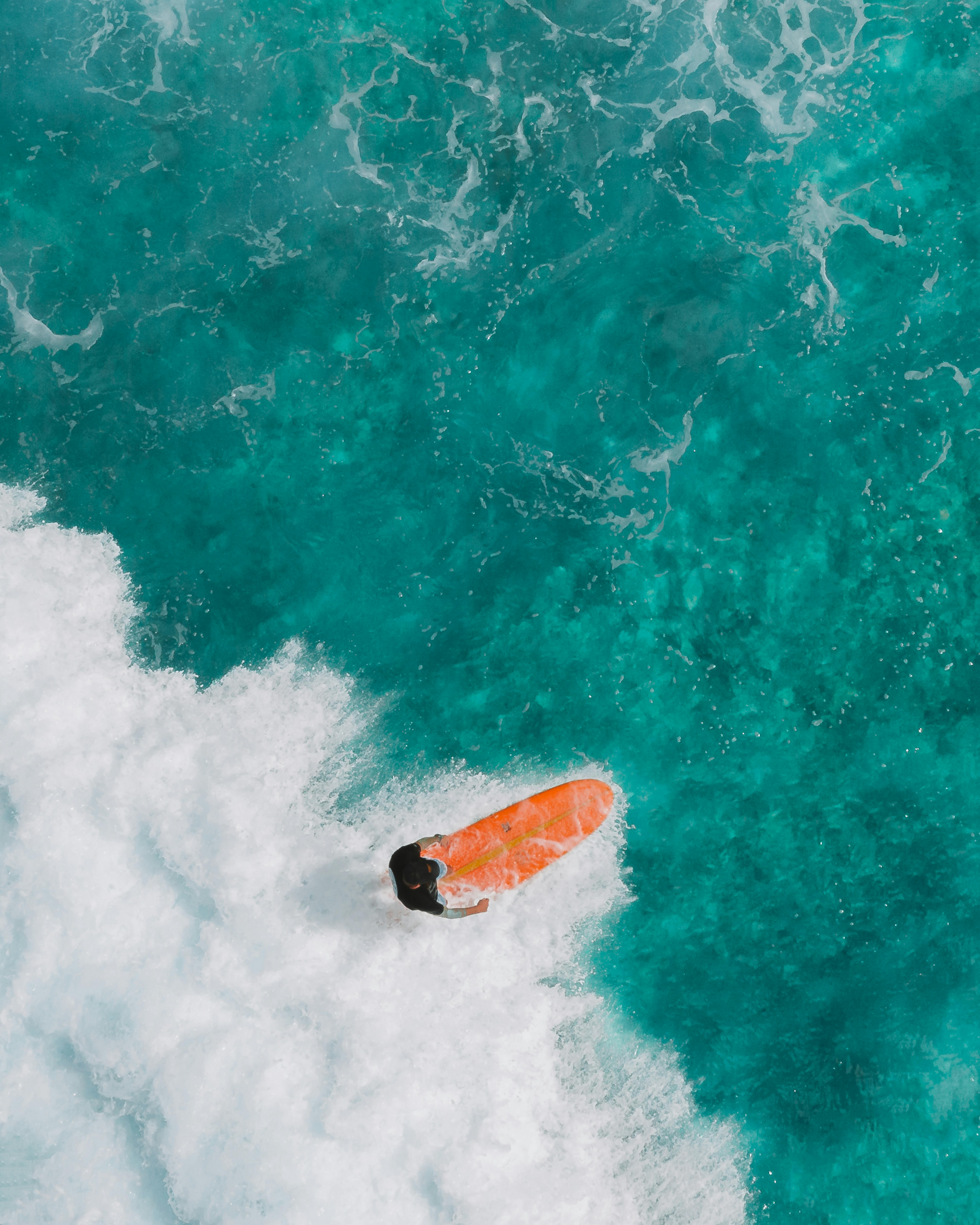 High-Angle Shot of a Person Surfboarding on Sea Waves · Free Stock Photo