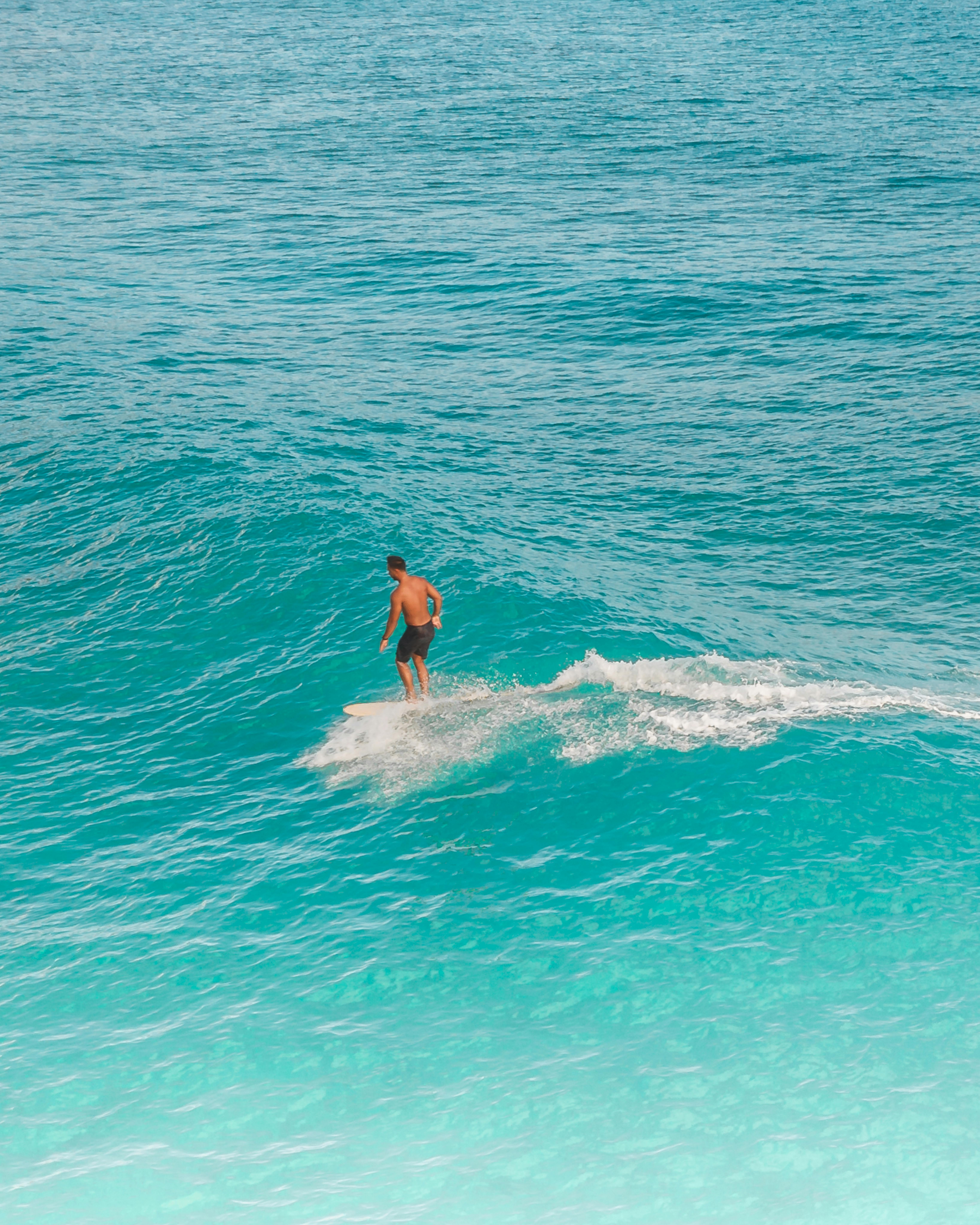 Man Surfing on Blue Sea · Free Stock Photo