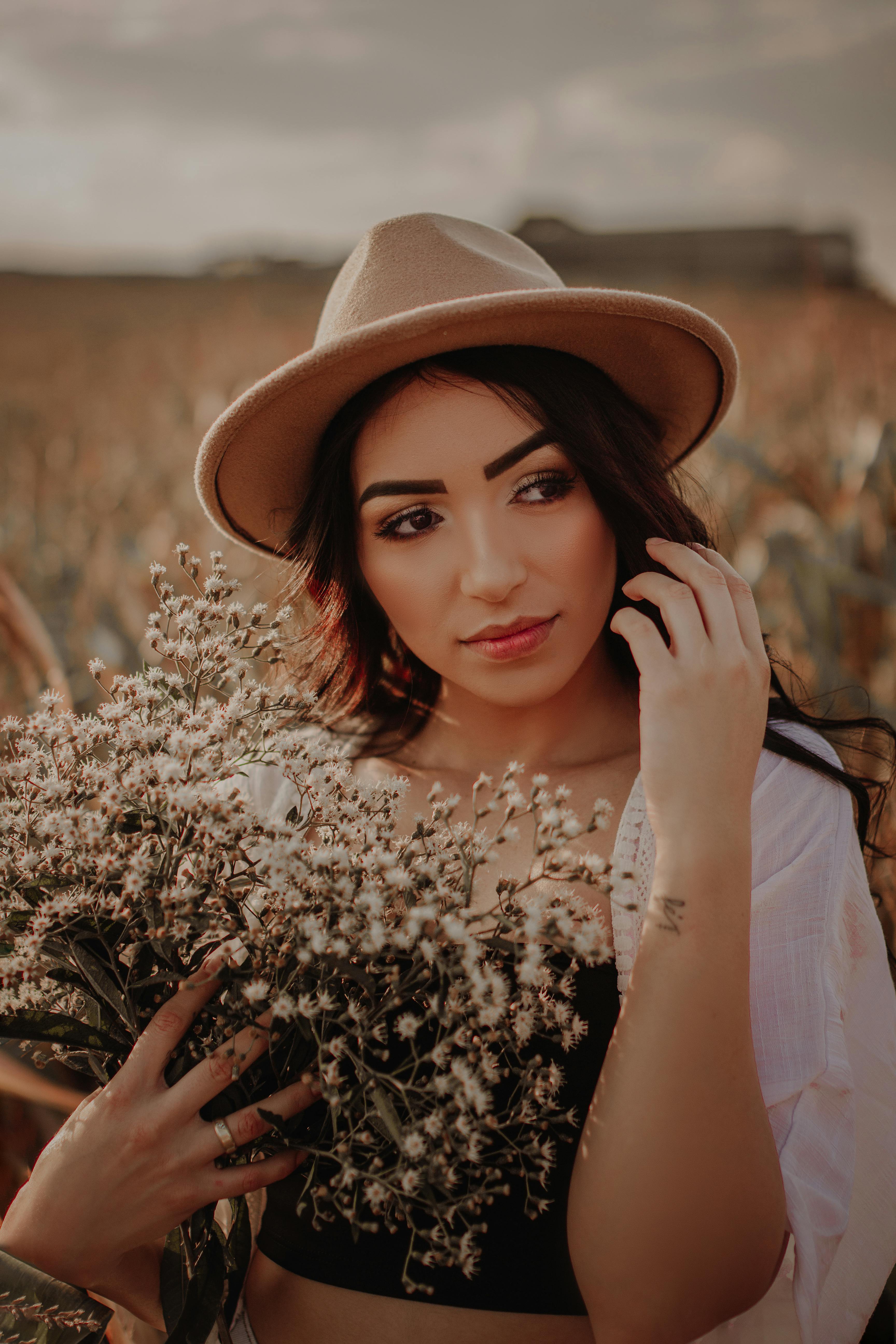 Woman Standing and Smelling Pink Petaled Flower · Free Stock Photo