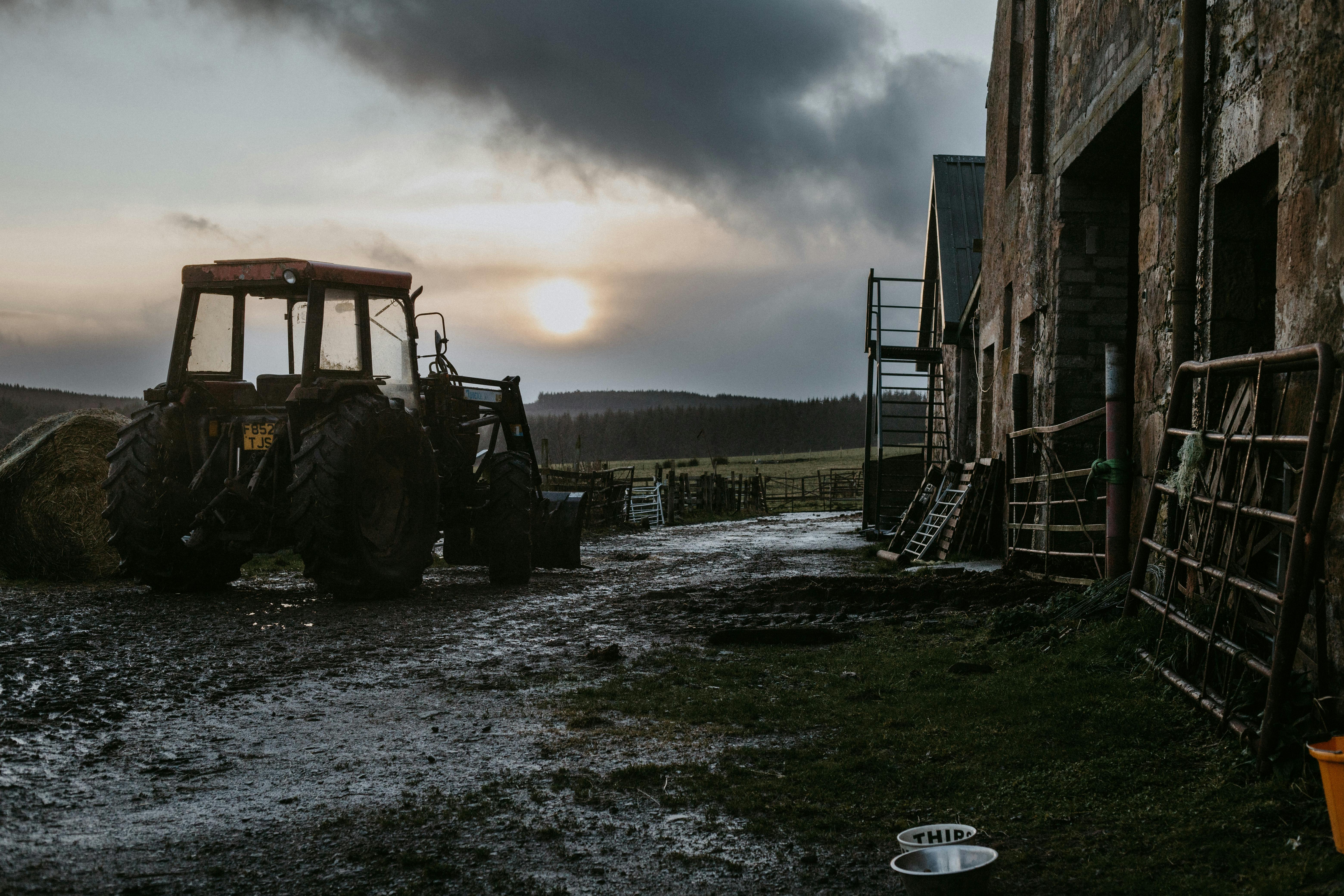 Parked Tractor on Wet and Muddy Ground · Free Stock Photo