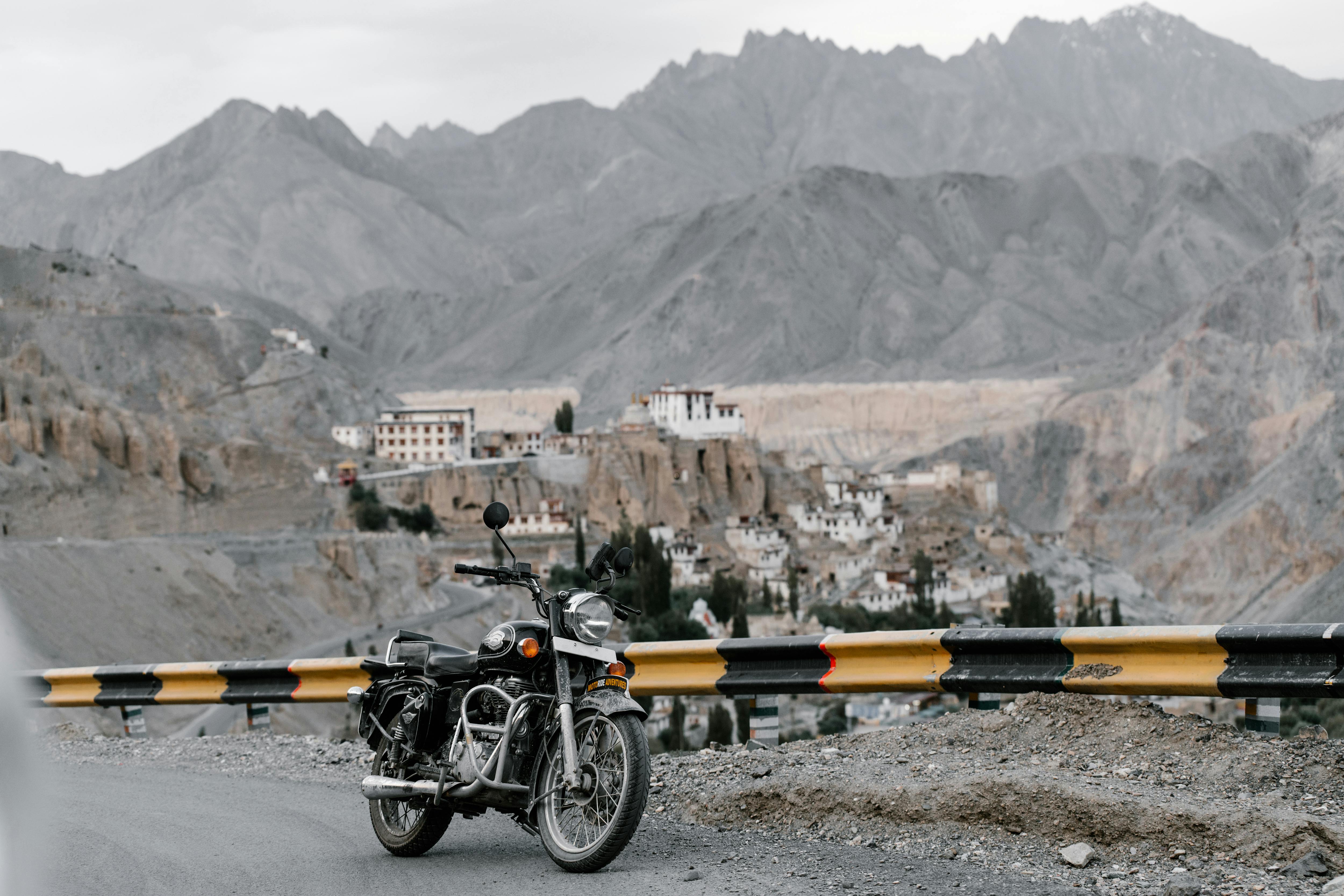 Motorbike Parked at Road in Mountain Desert Landscape · Free Stock Photo