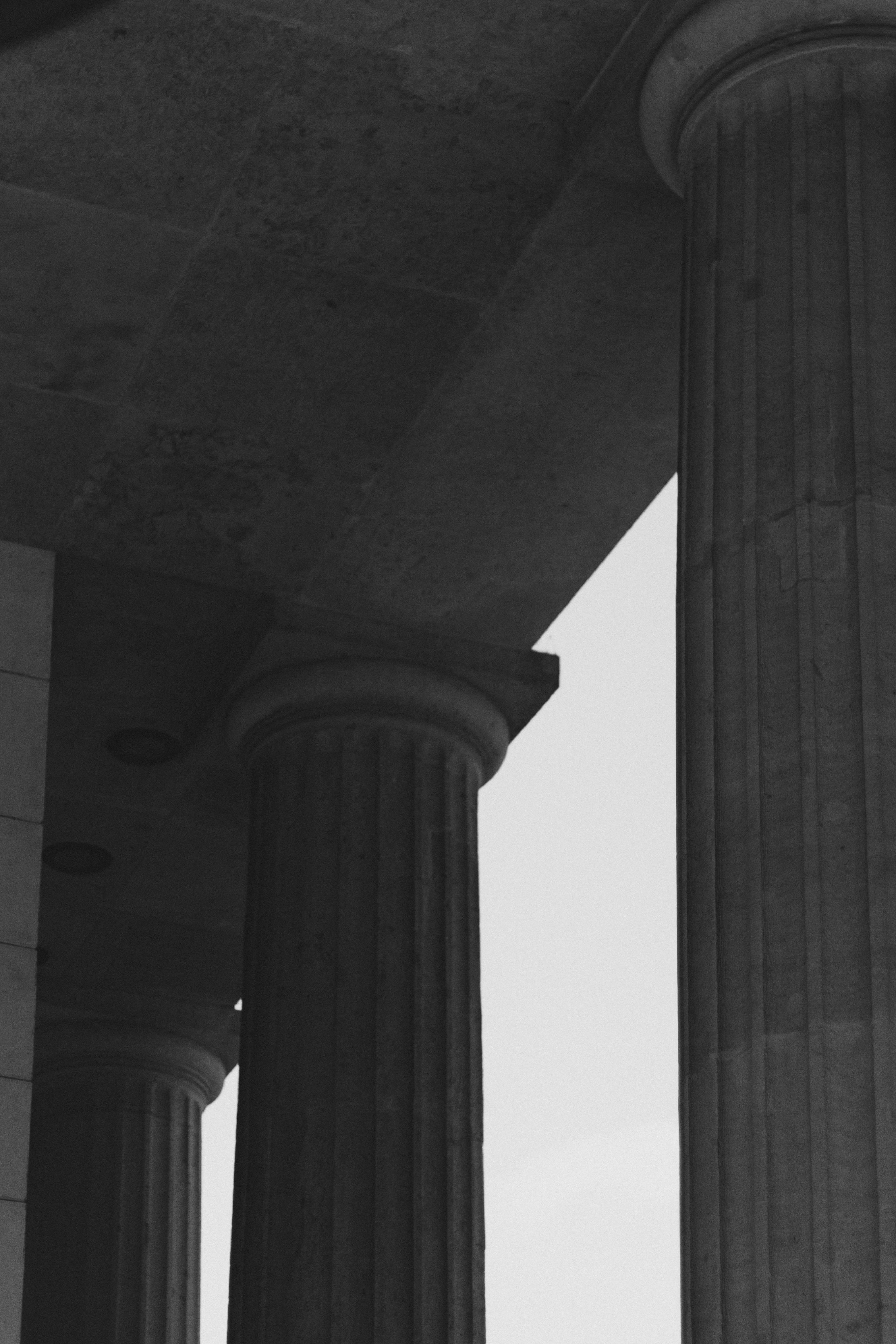 Grayscale Photo of Concrete Pillars · Free Stock Photo