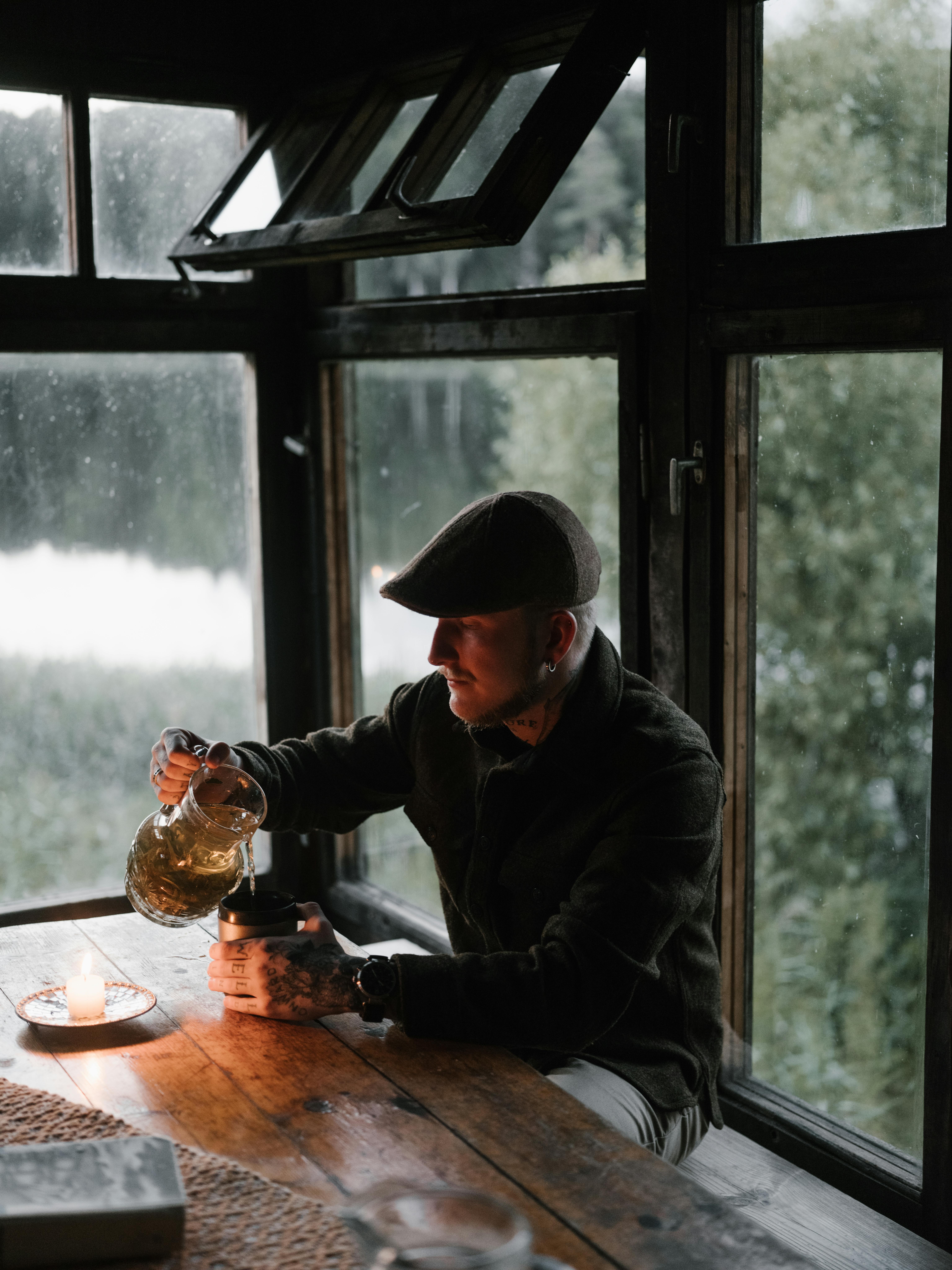 A Man Pouring Water on a Cup · Free Stock Photo