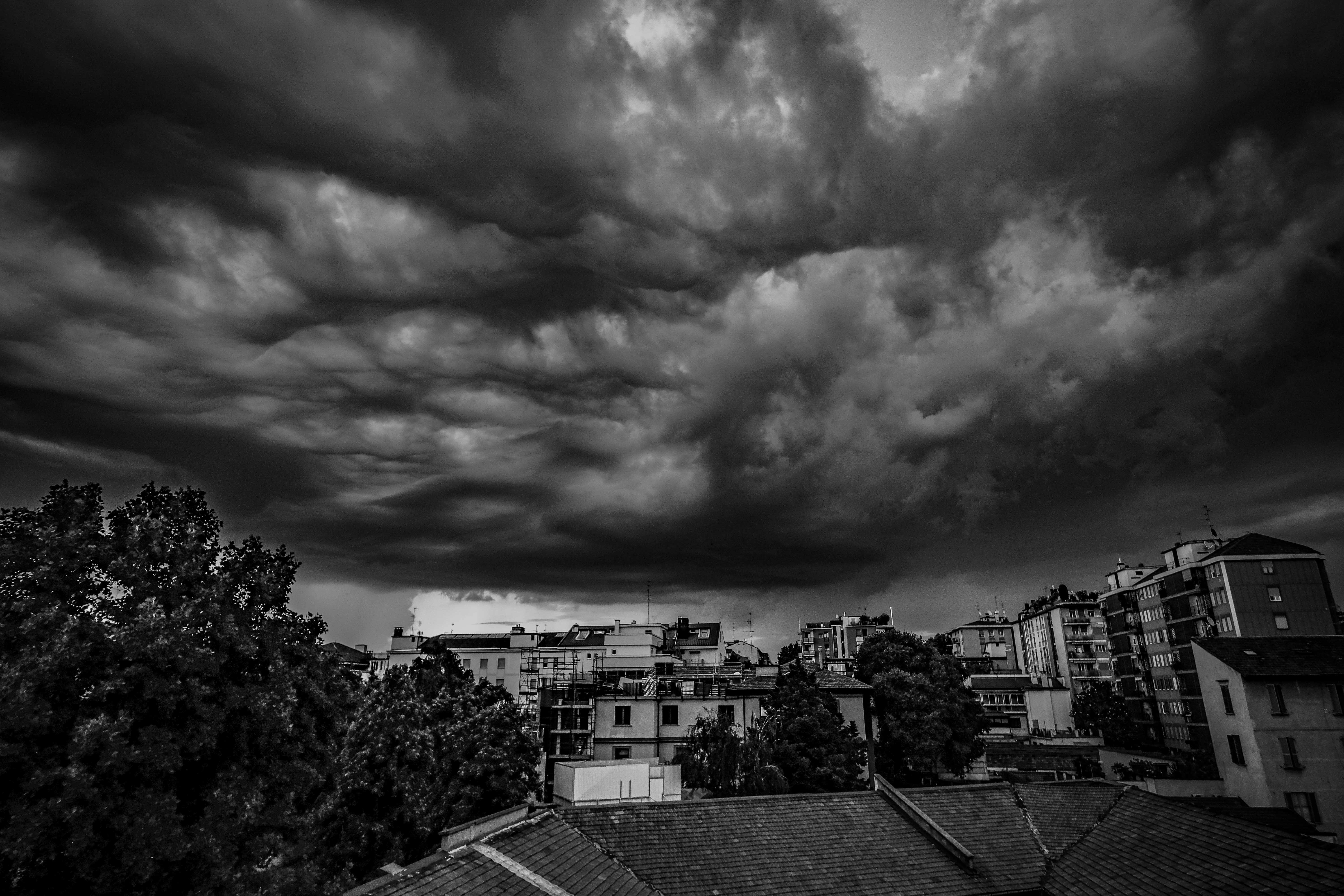 Cityscape with residential buildings against dramatic overcast sky ...