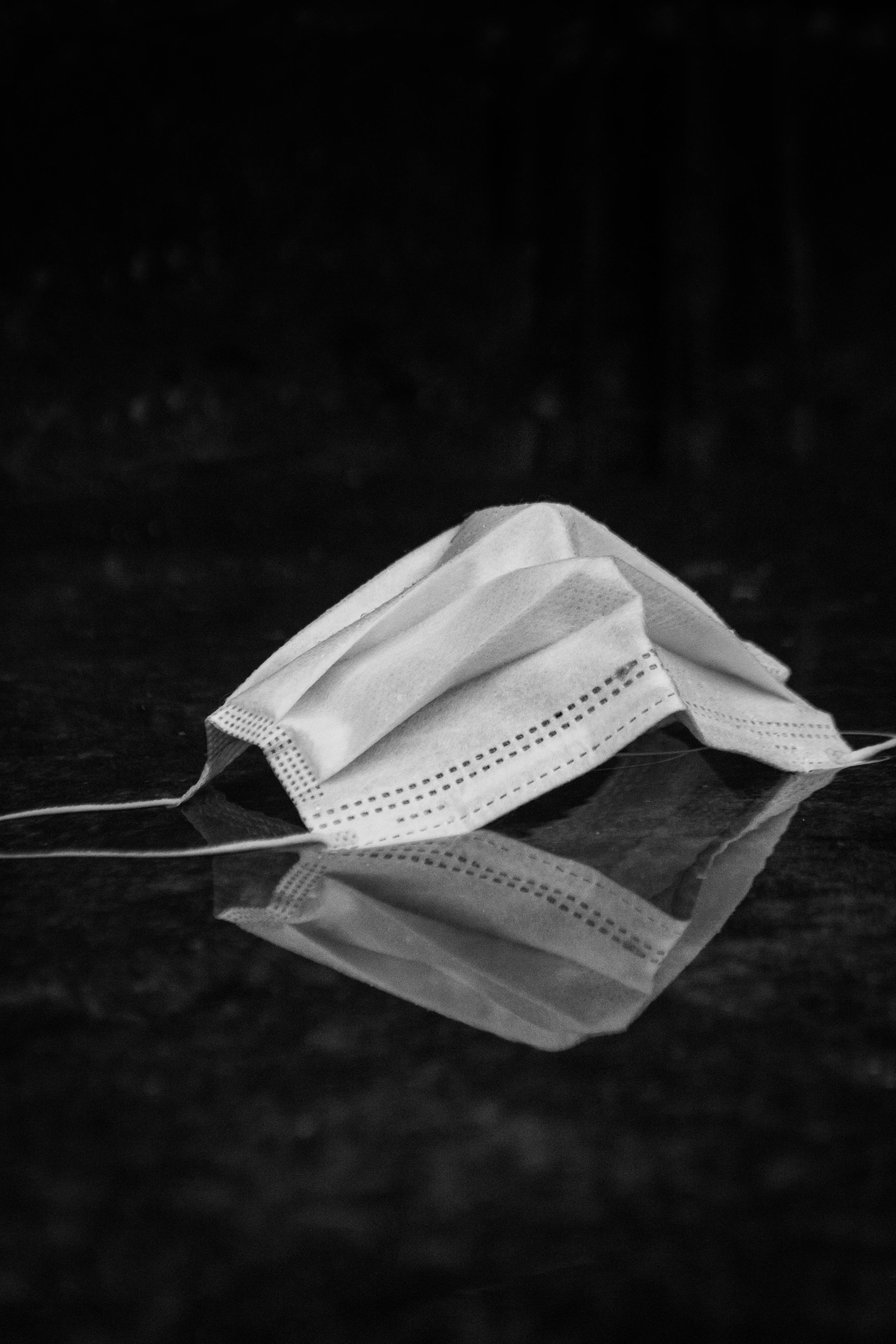 Grayscale Photo of a Used Face Mask · Free Stock Photo