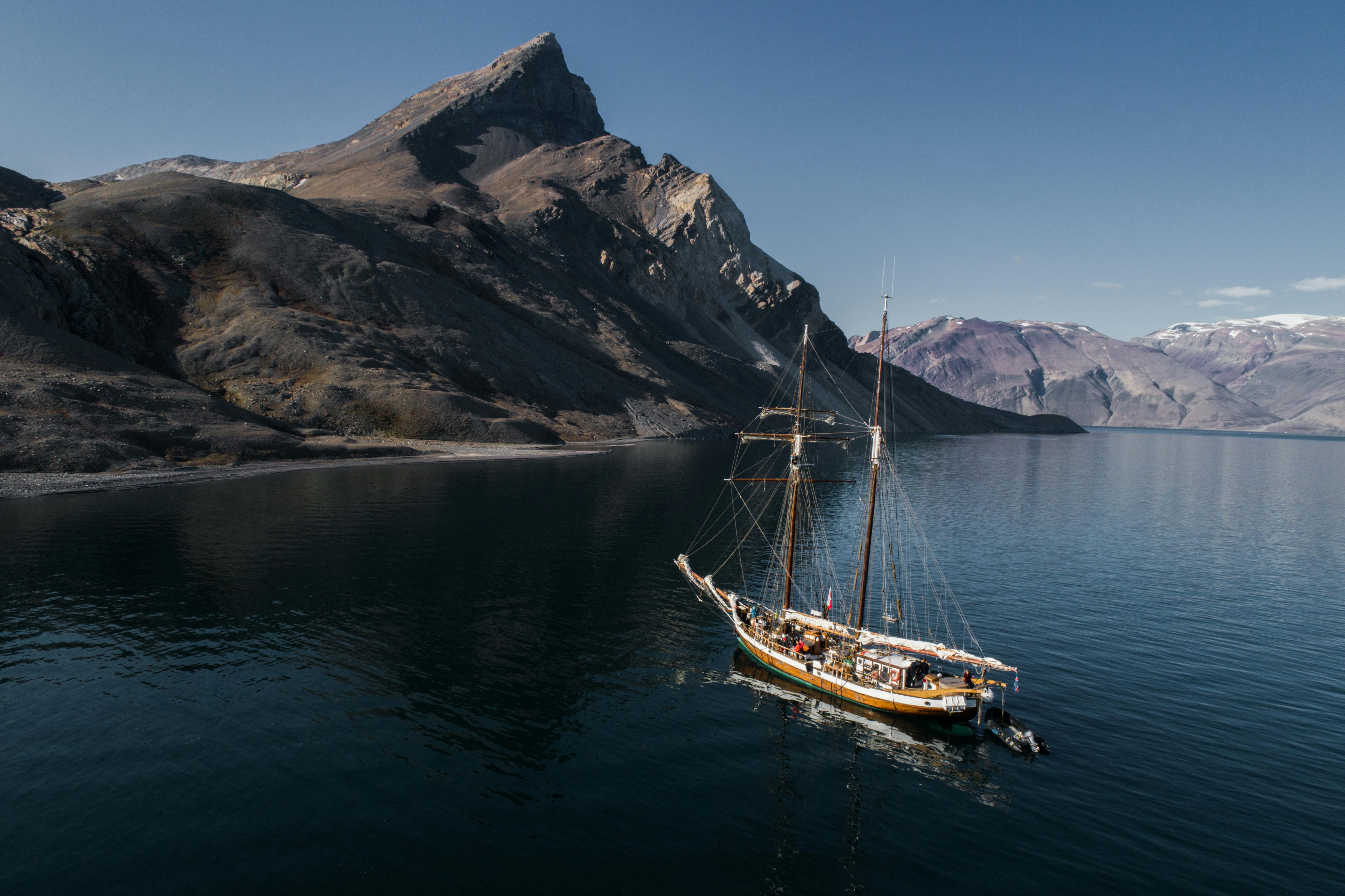 Sailboat Sailing on Water Near Island · Free Stock Photo