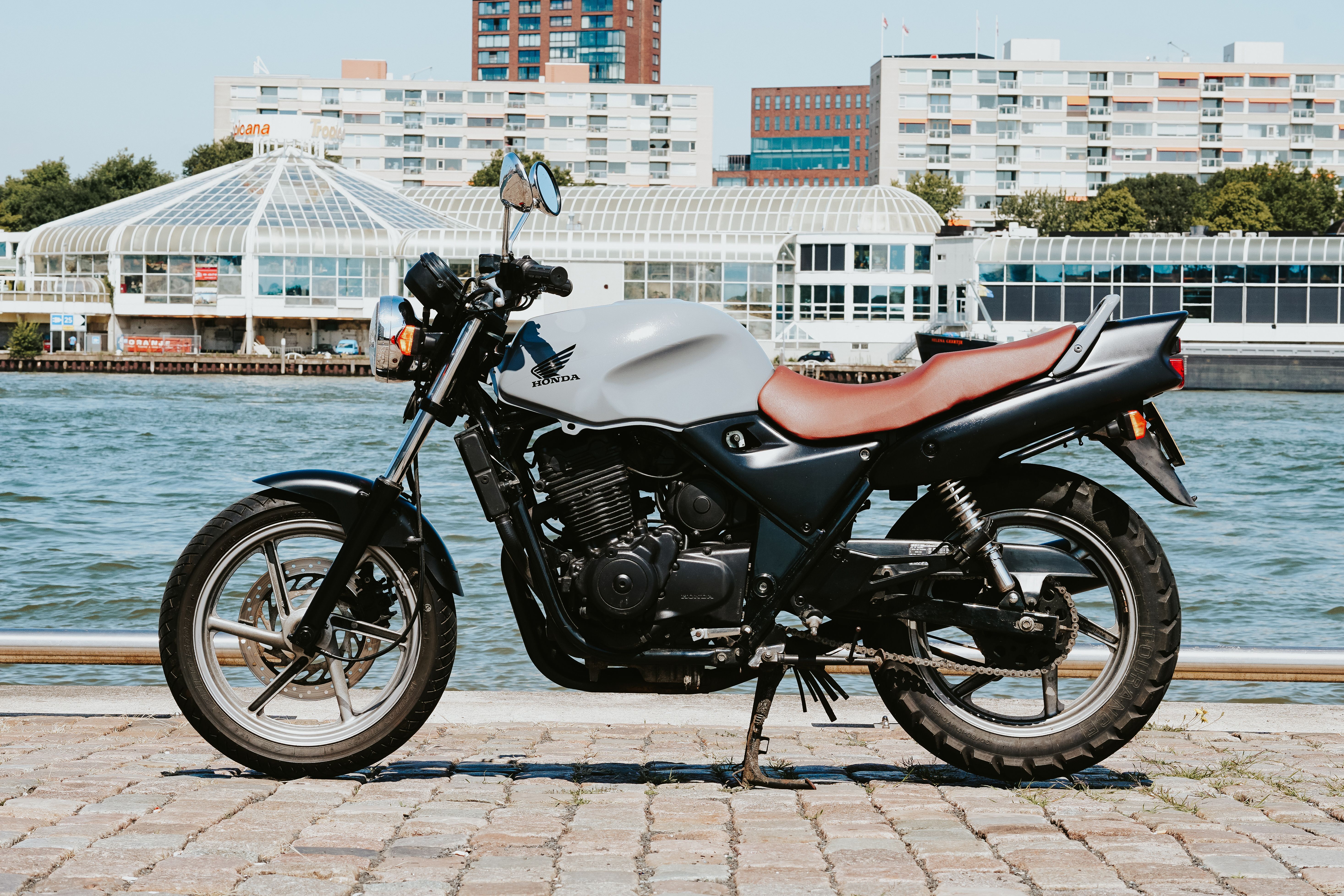 Motorcycle Parked by River · Free Stock Photo