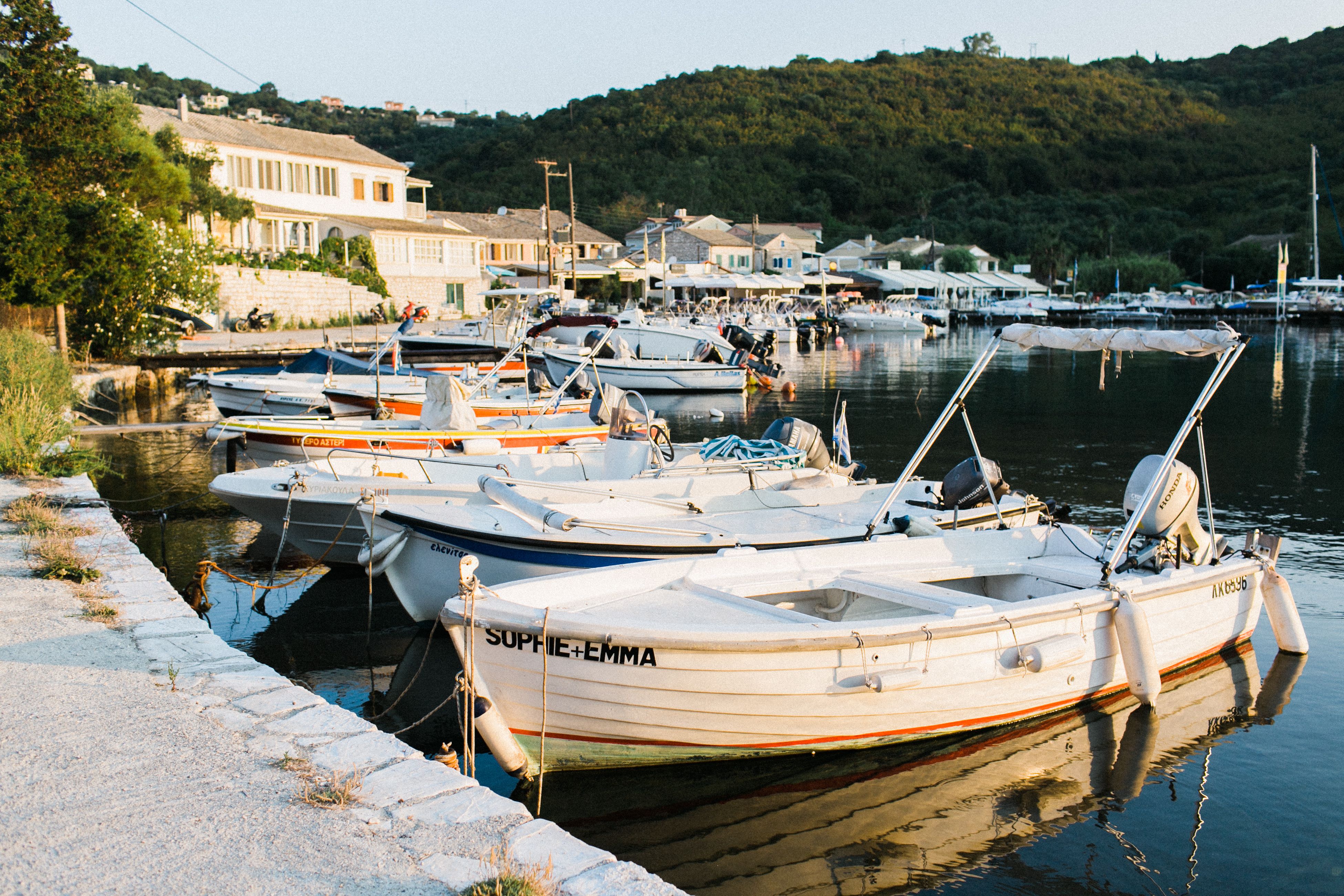 Sailboats at stone port of small town · Free Stock Photo