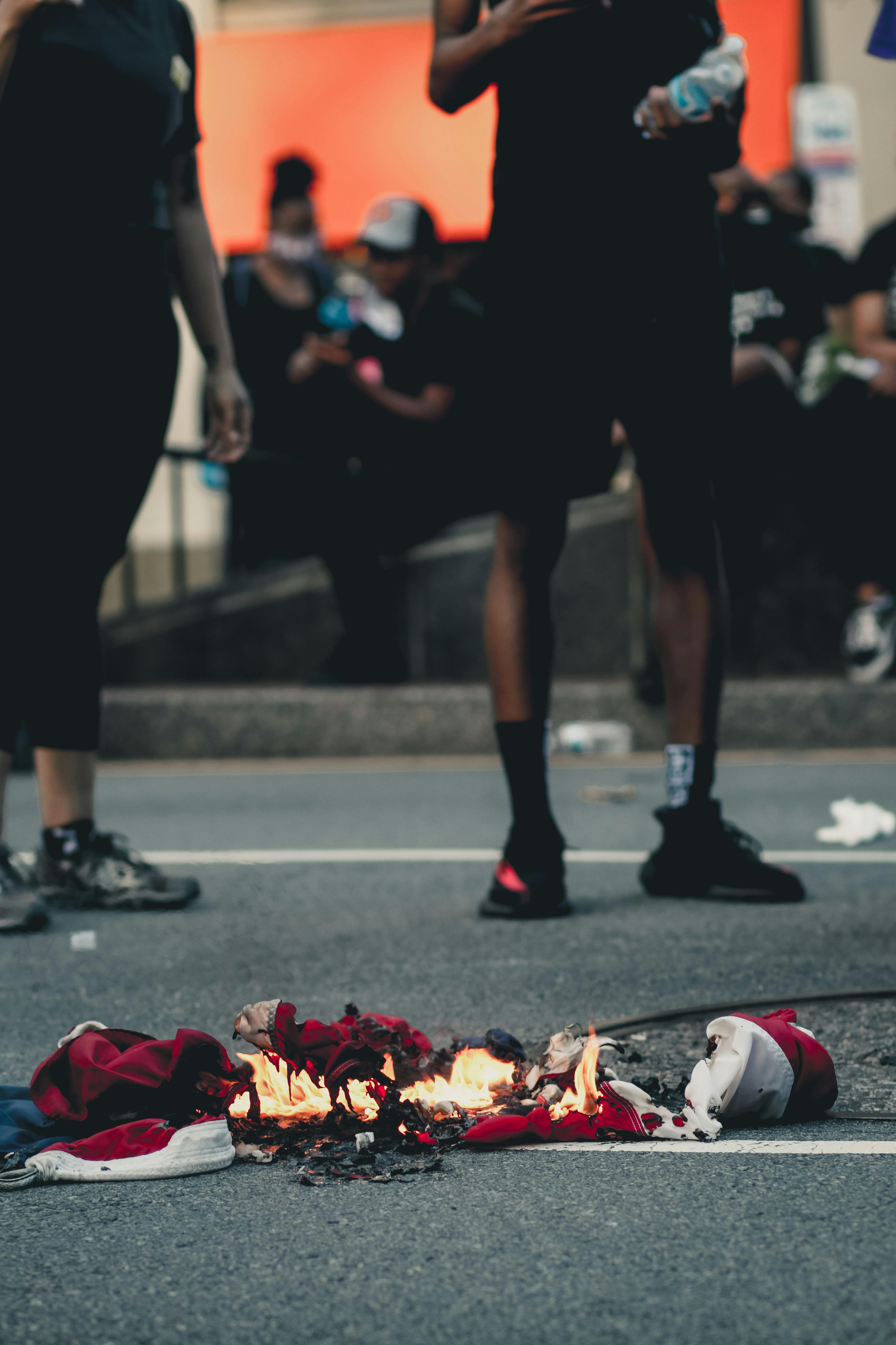 Flaming clothes and shoes on pavement · Free Stock Photo