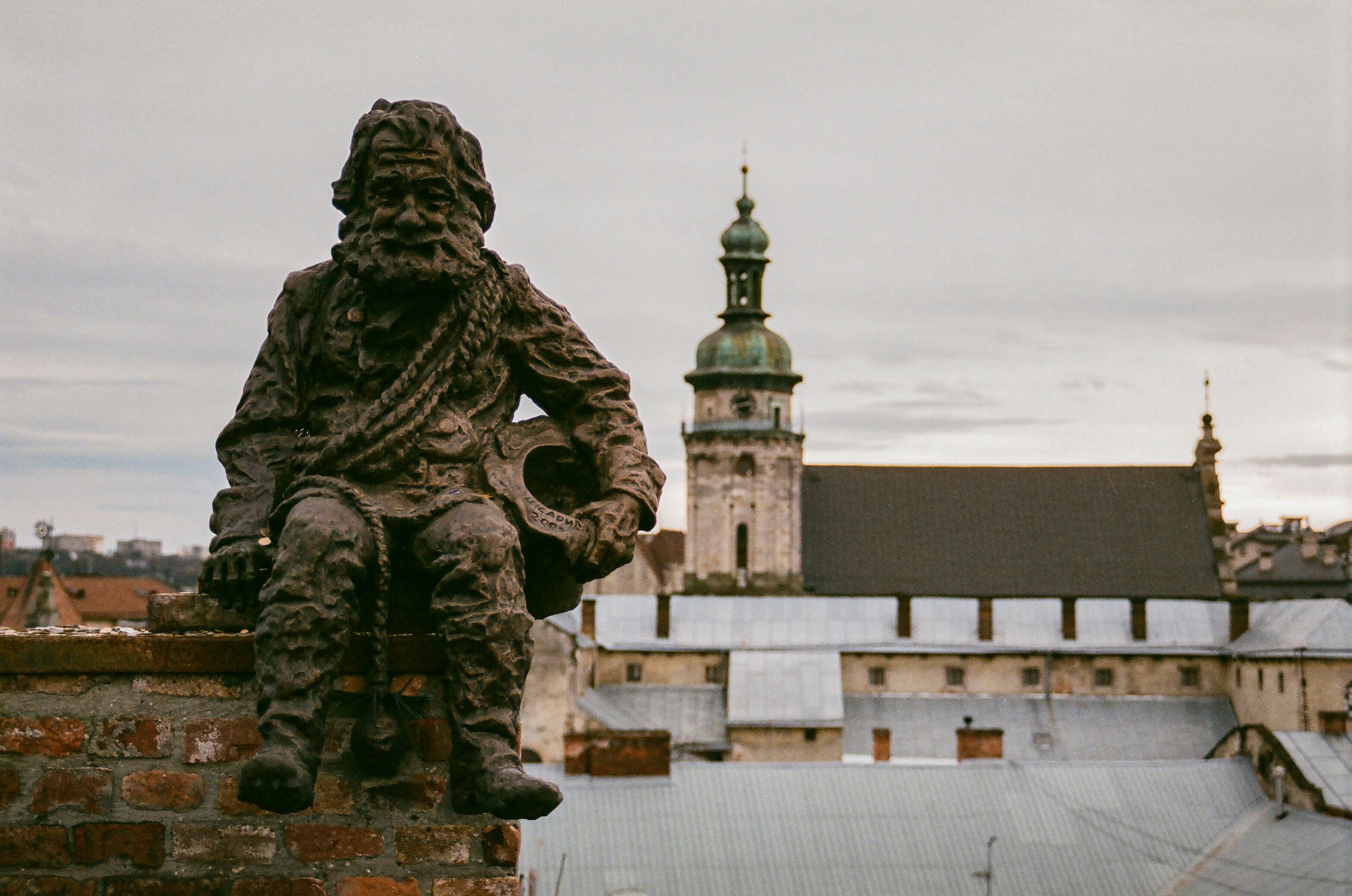 Statue of Man Carrying Scrolls · Free Stock Photo