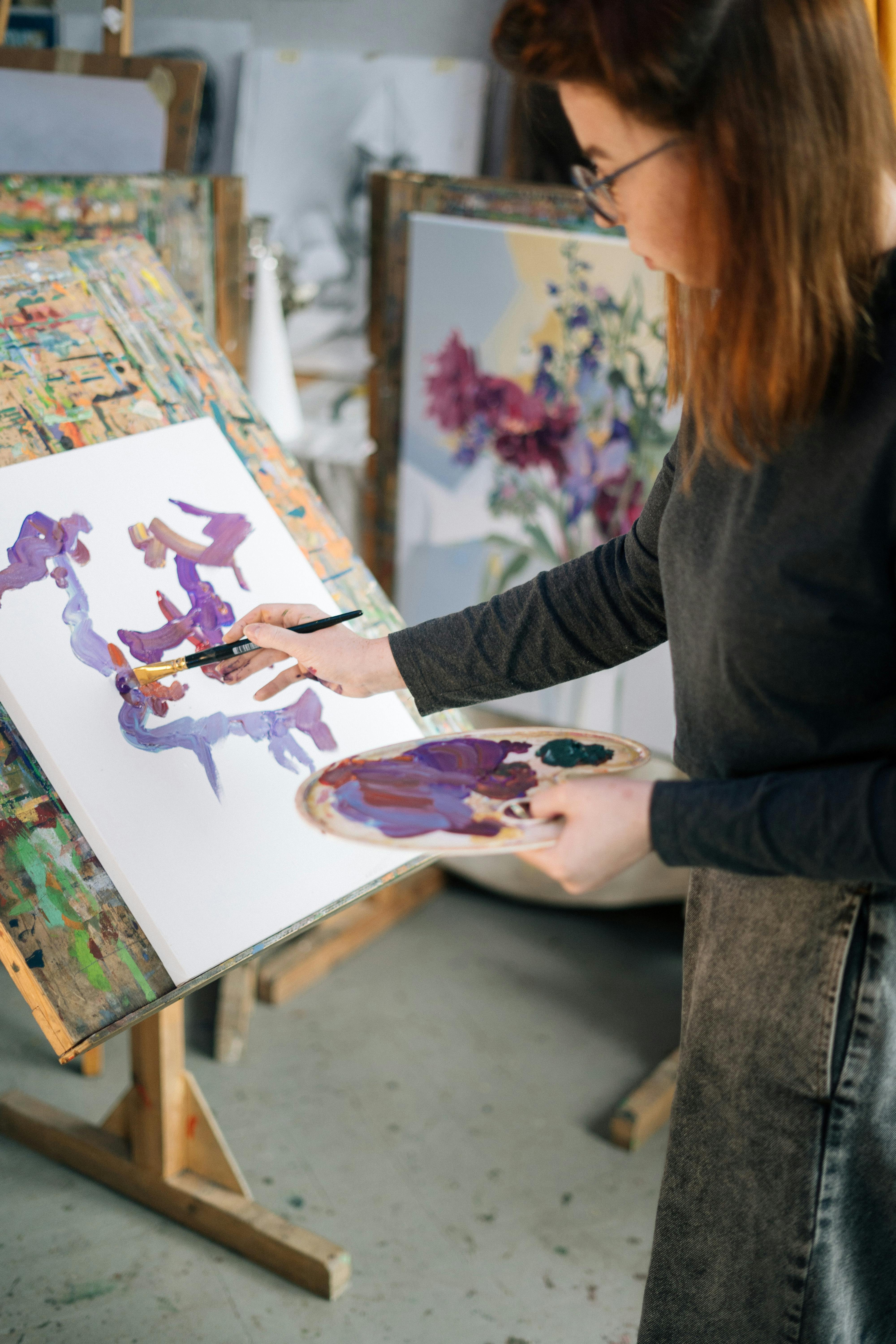 A Painter Painting on a Canvas · Free Stock Photo