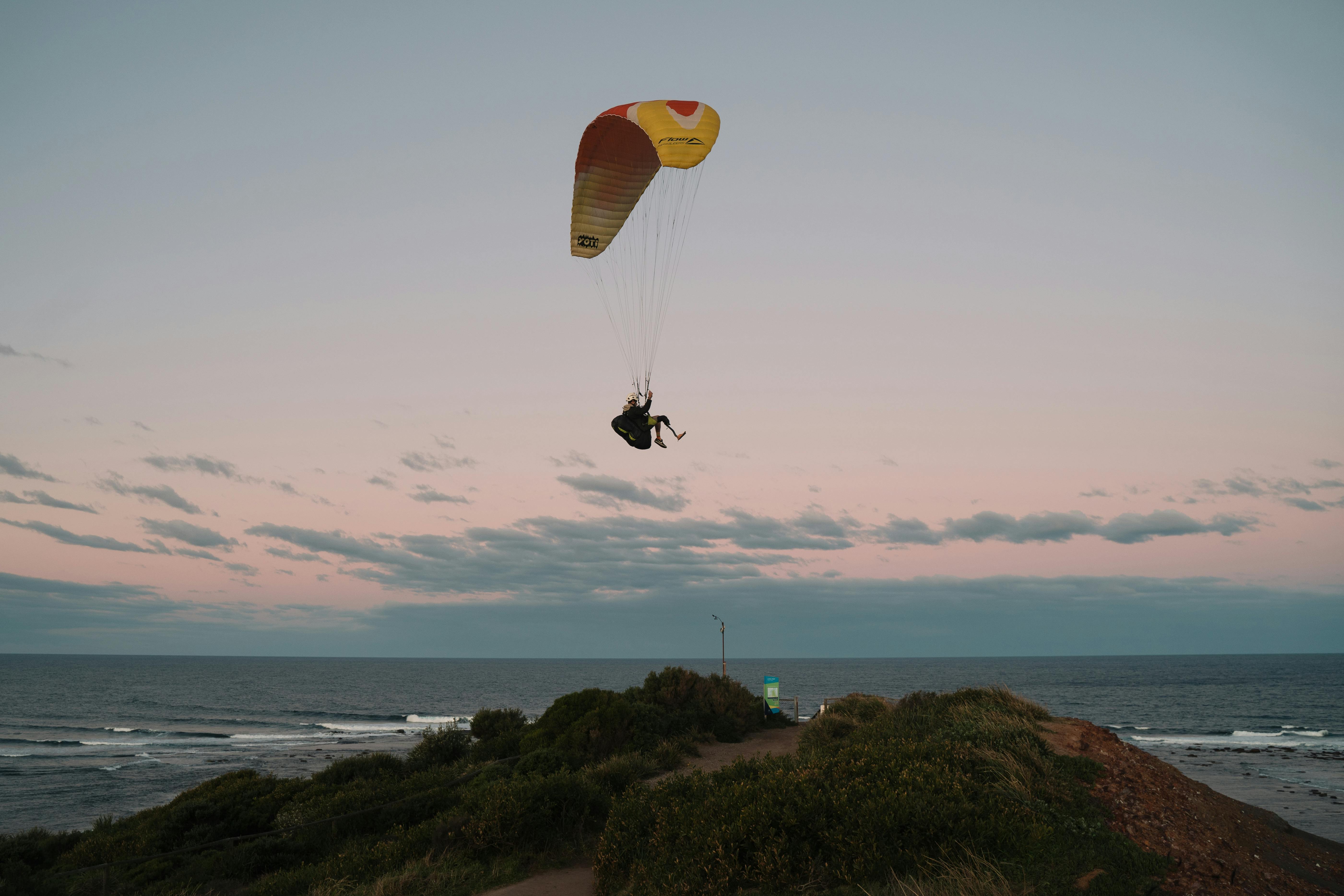 Man Paragliding over the Sea · Free Stock Photo