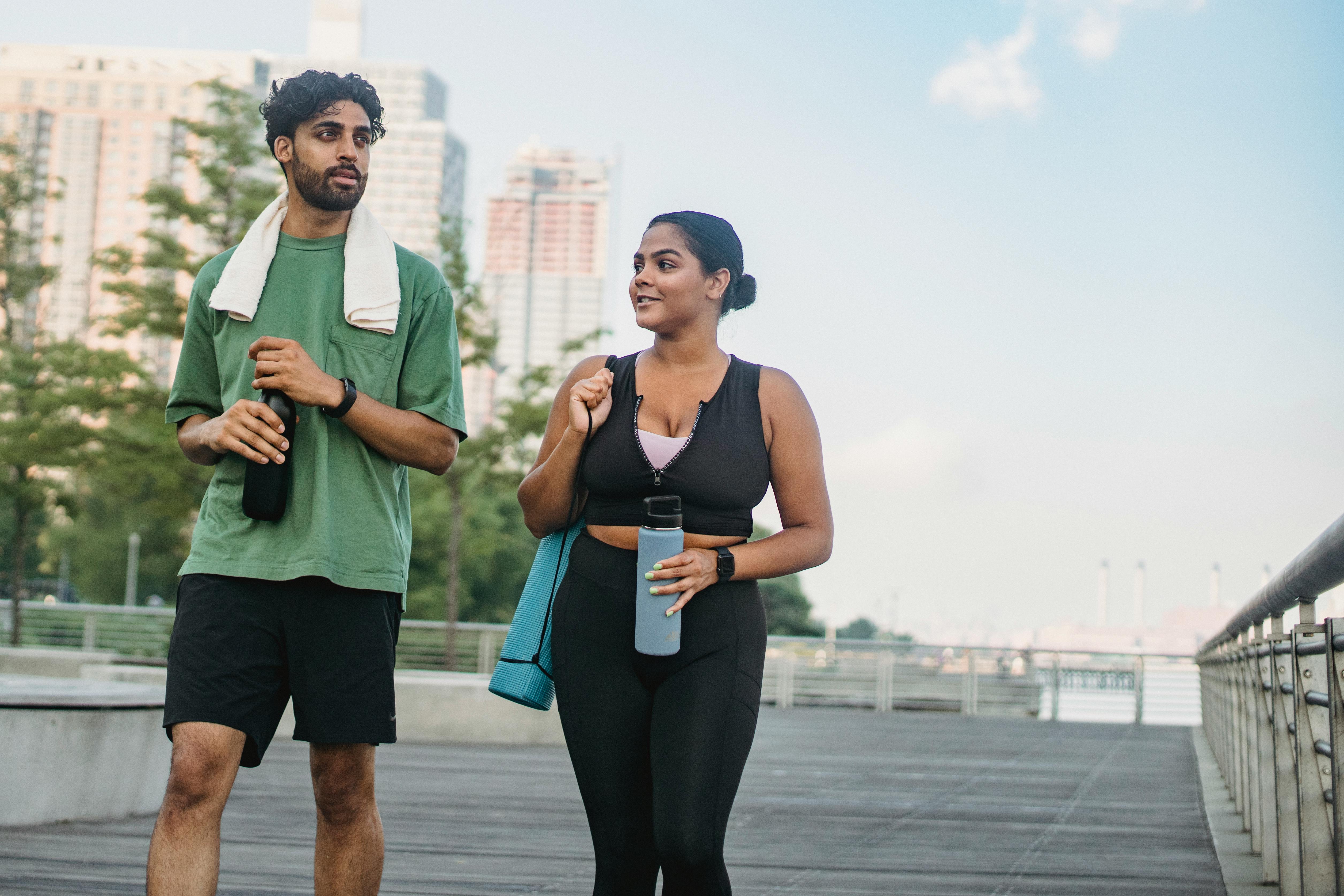 Man and Woman Walking on Broadwalk · Free Stock Photo