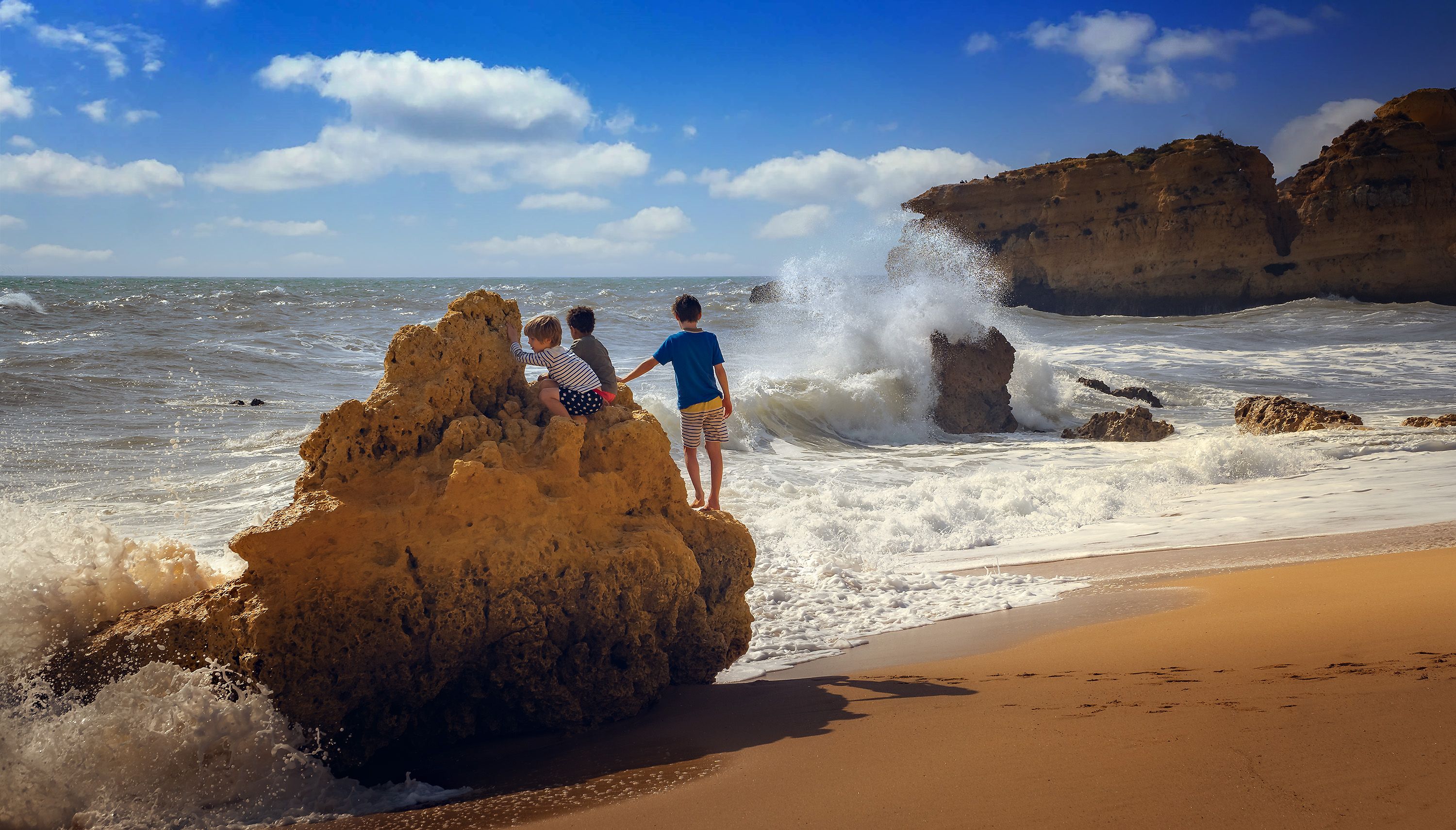 Children Climbing Small Rock on Beach · Free Stock Photo