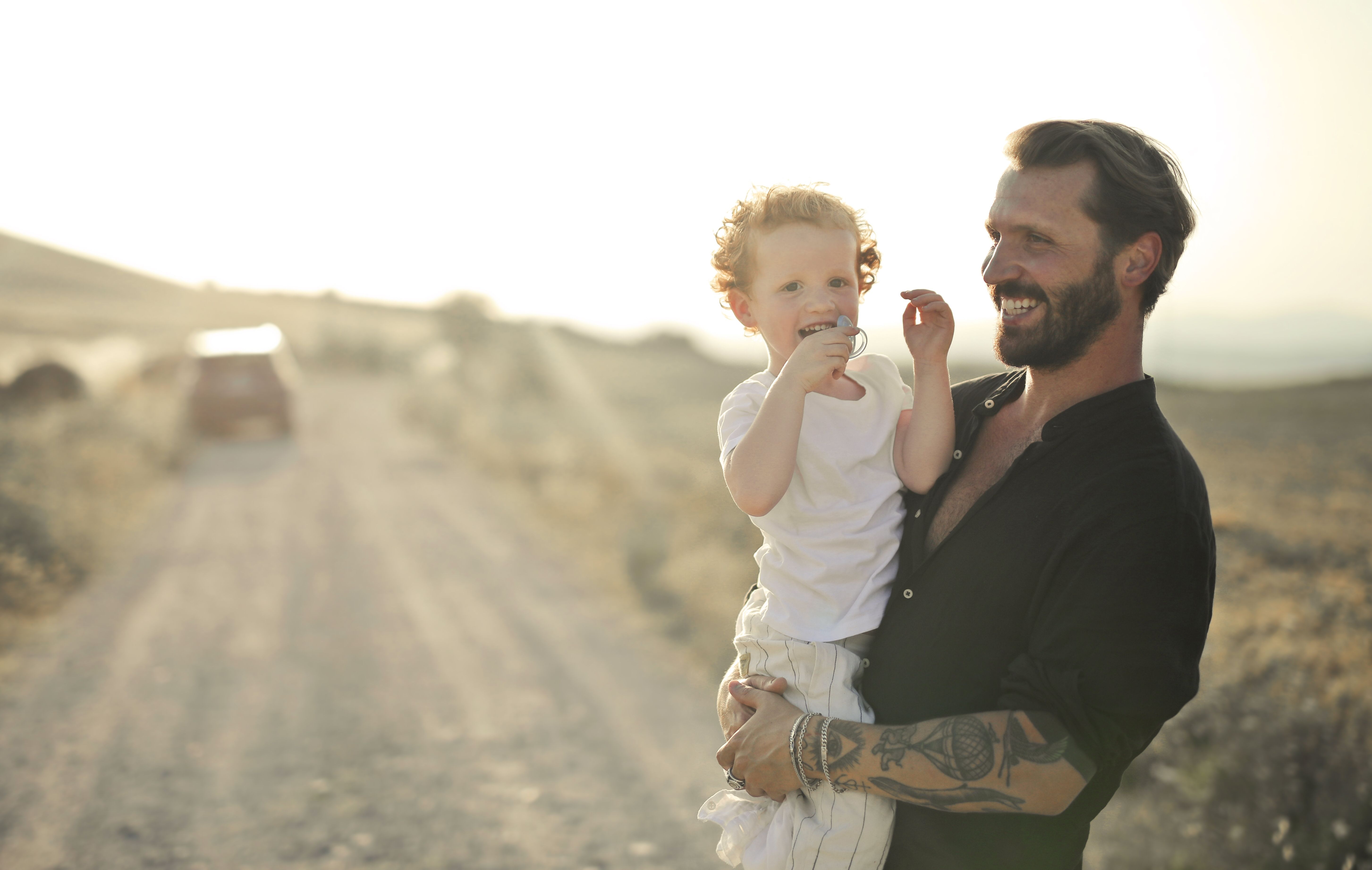 Happy Father with Child on Countryside Road · Free Stock Photo