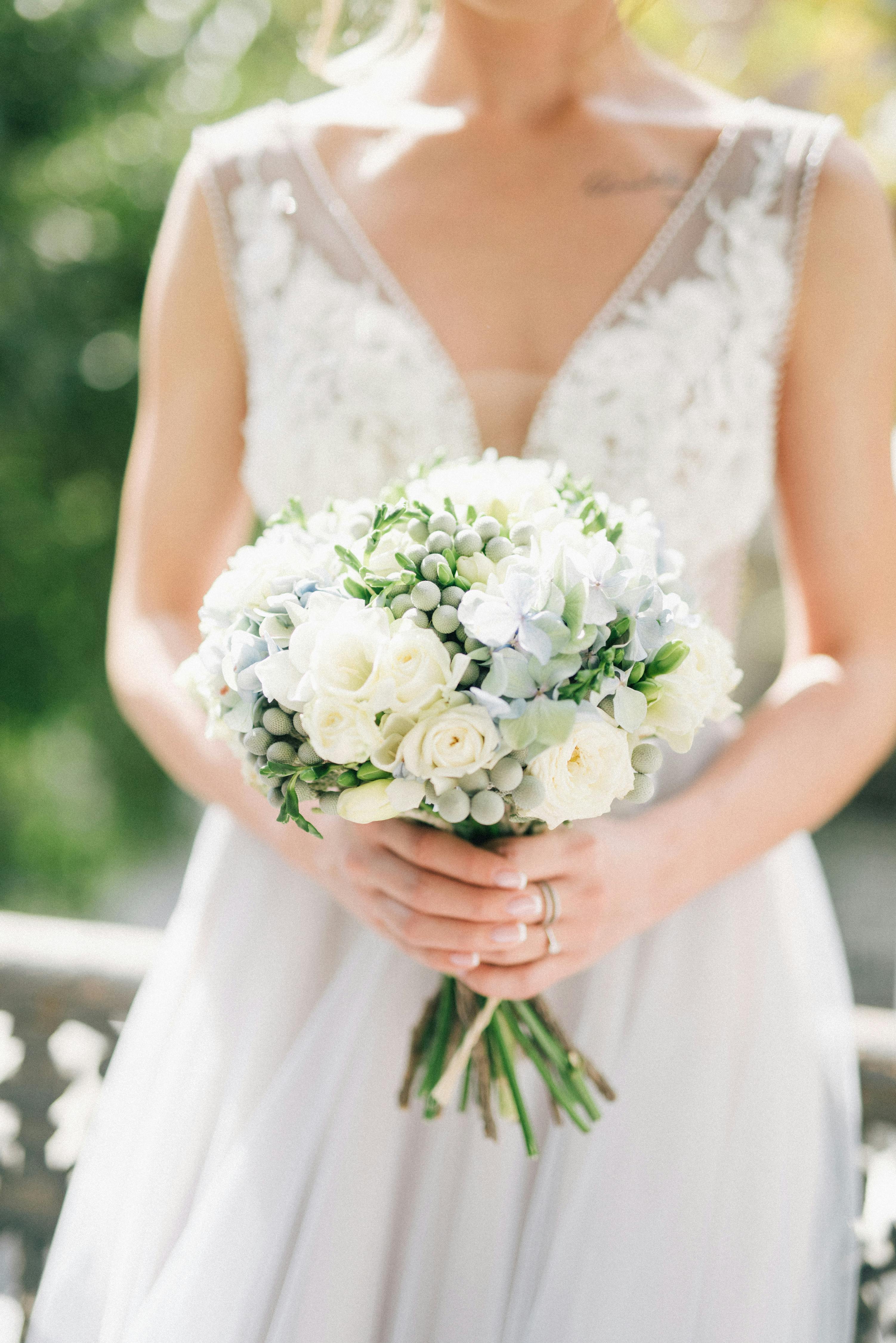 A Bride Holding Her Bouquet · Free Stock Photo