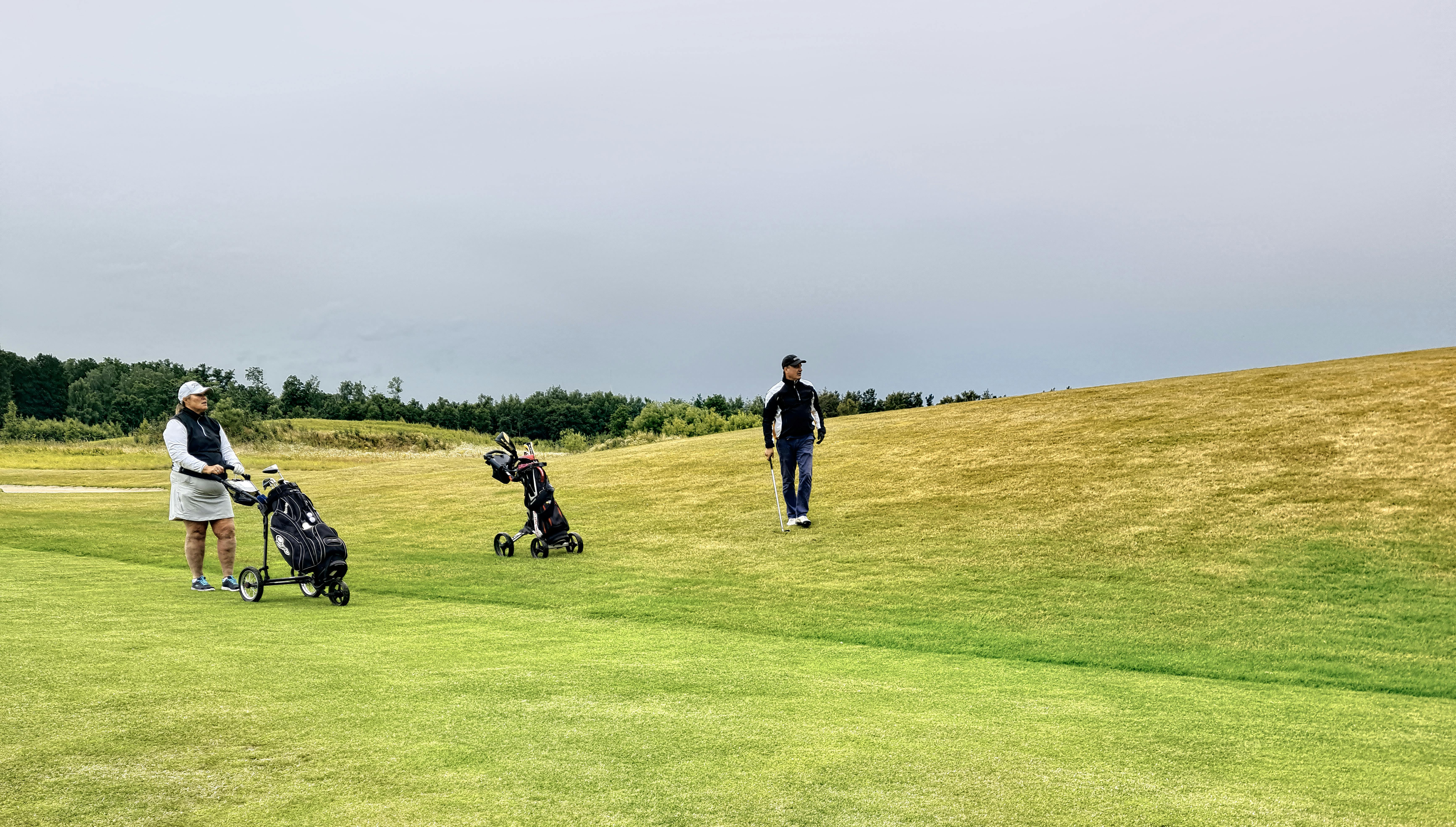 Man and Woman on Golf Course · Free Stock Photo
