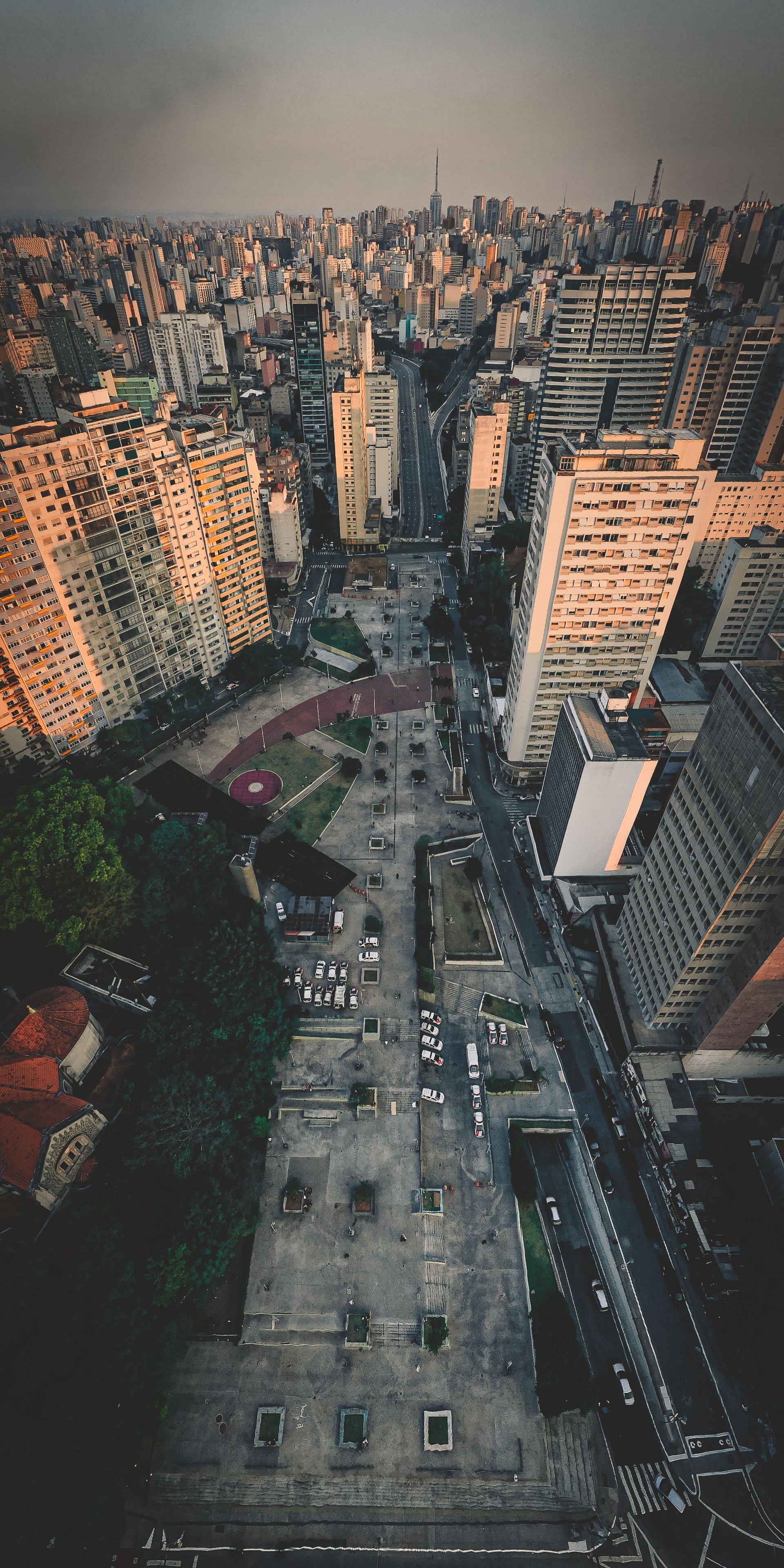 Modern glowing city street with road between buildings · Free Stock Photo
