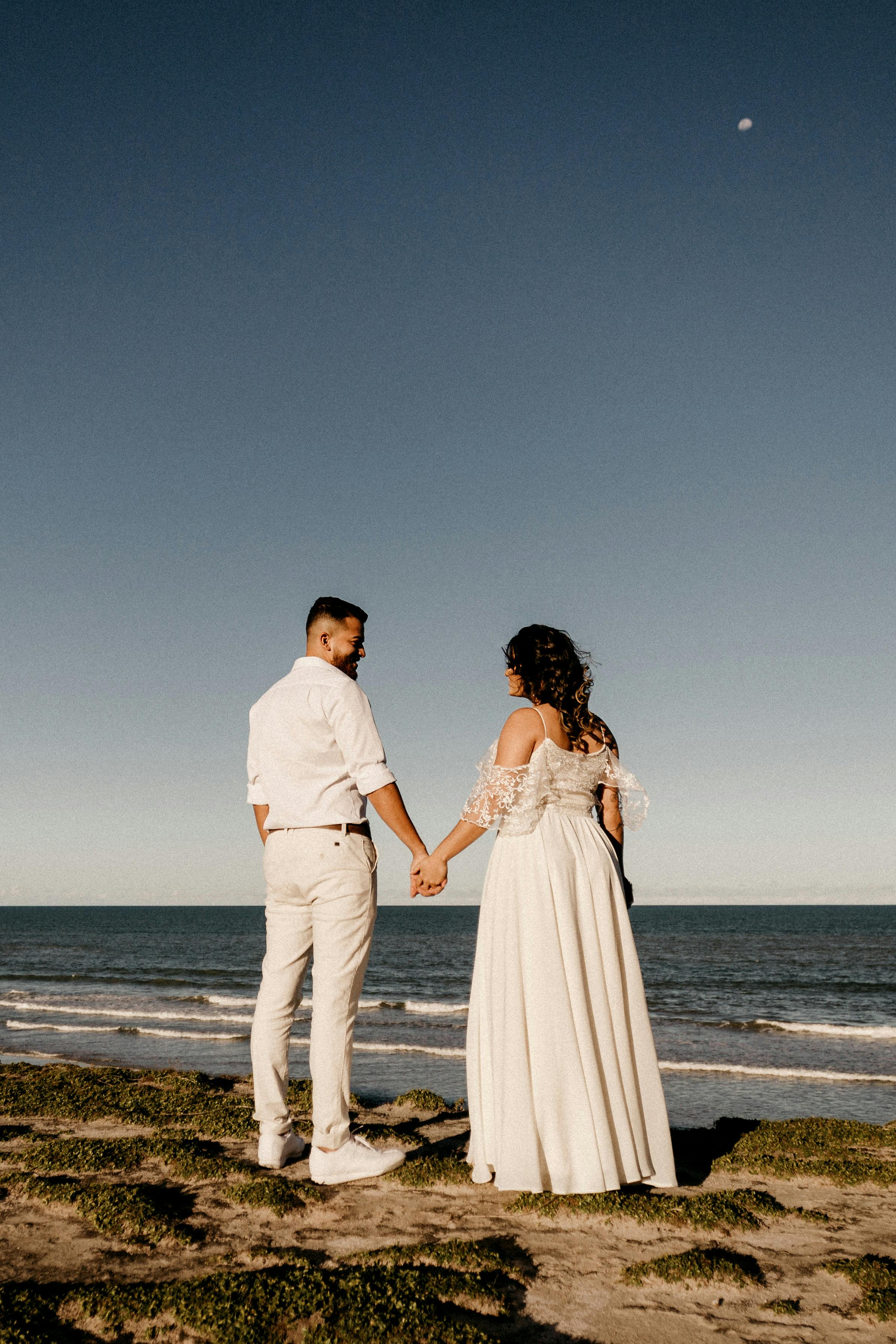 Anonymous Just Married Couple Holding Hands On Sandy Ocean Shore · Free