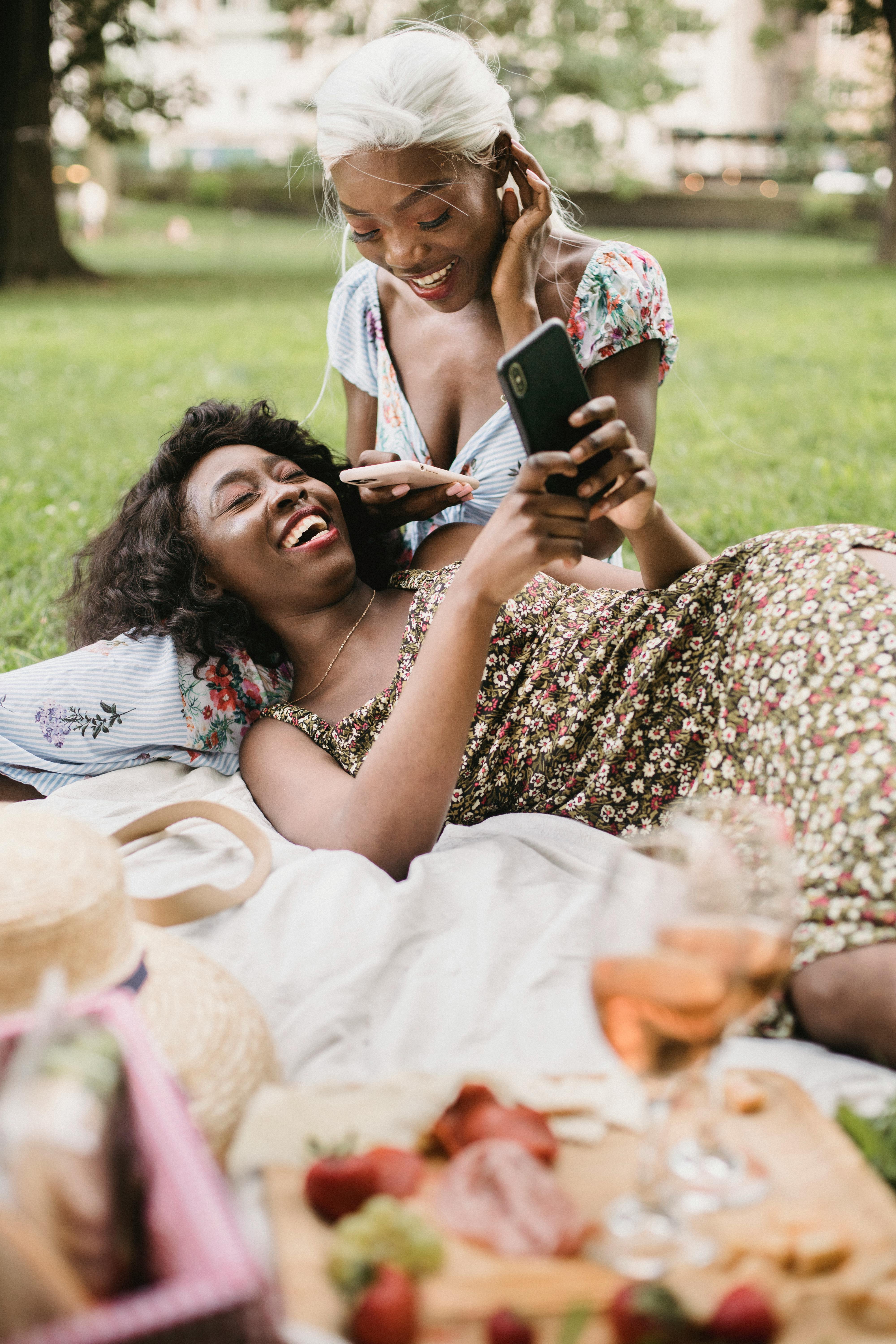 Woman Resting Her Head on Lap of a Woman on Green Grass · Free Stock Photo