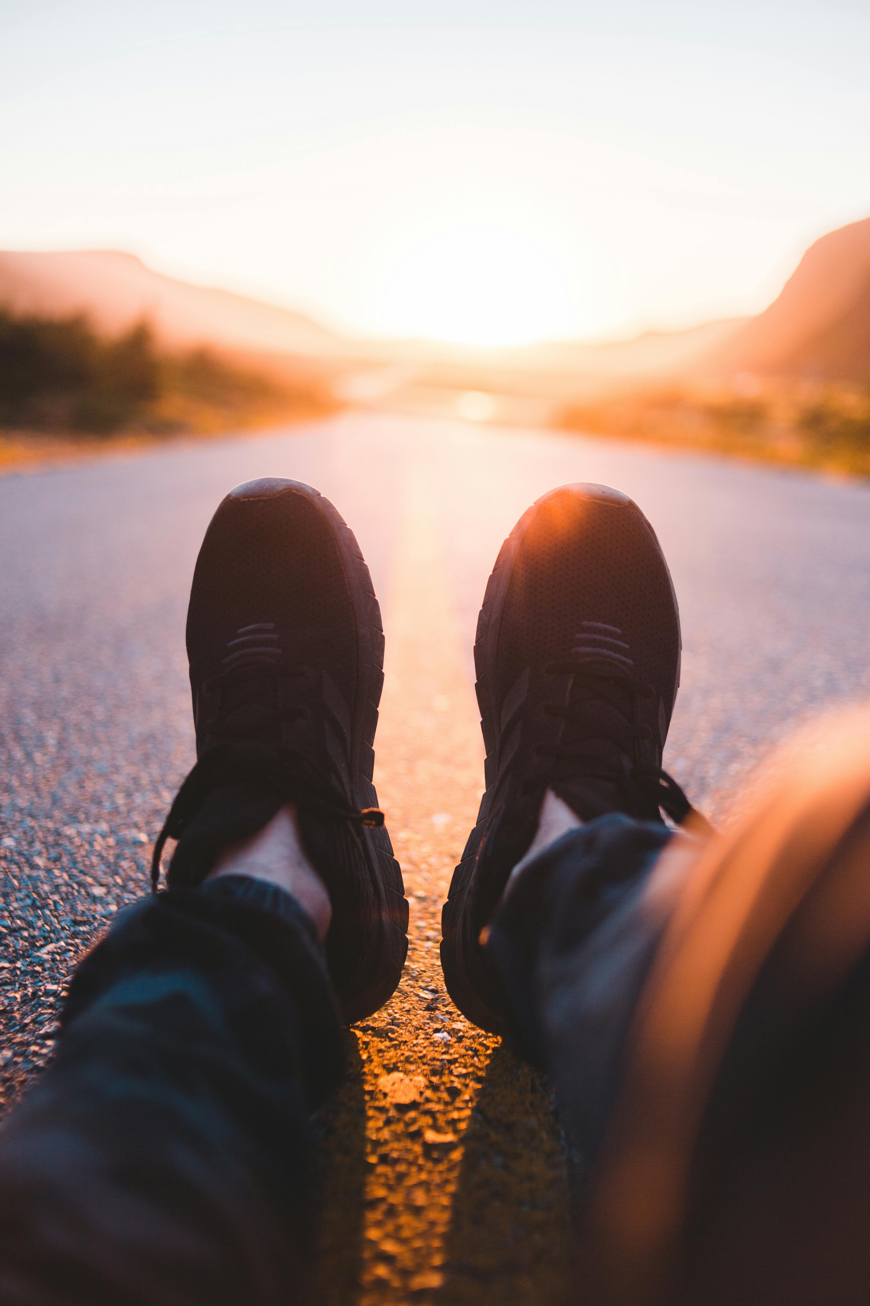Silhouette of person standing against sunset sky · Free Stock Photo