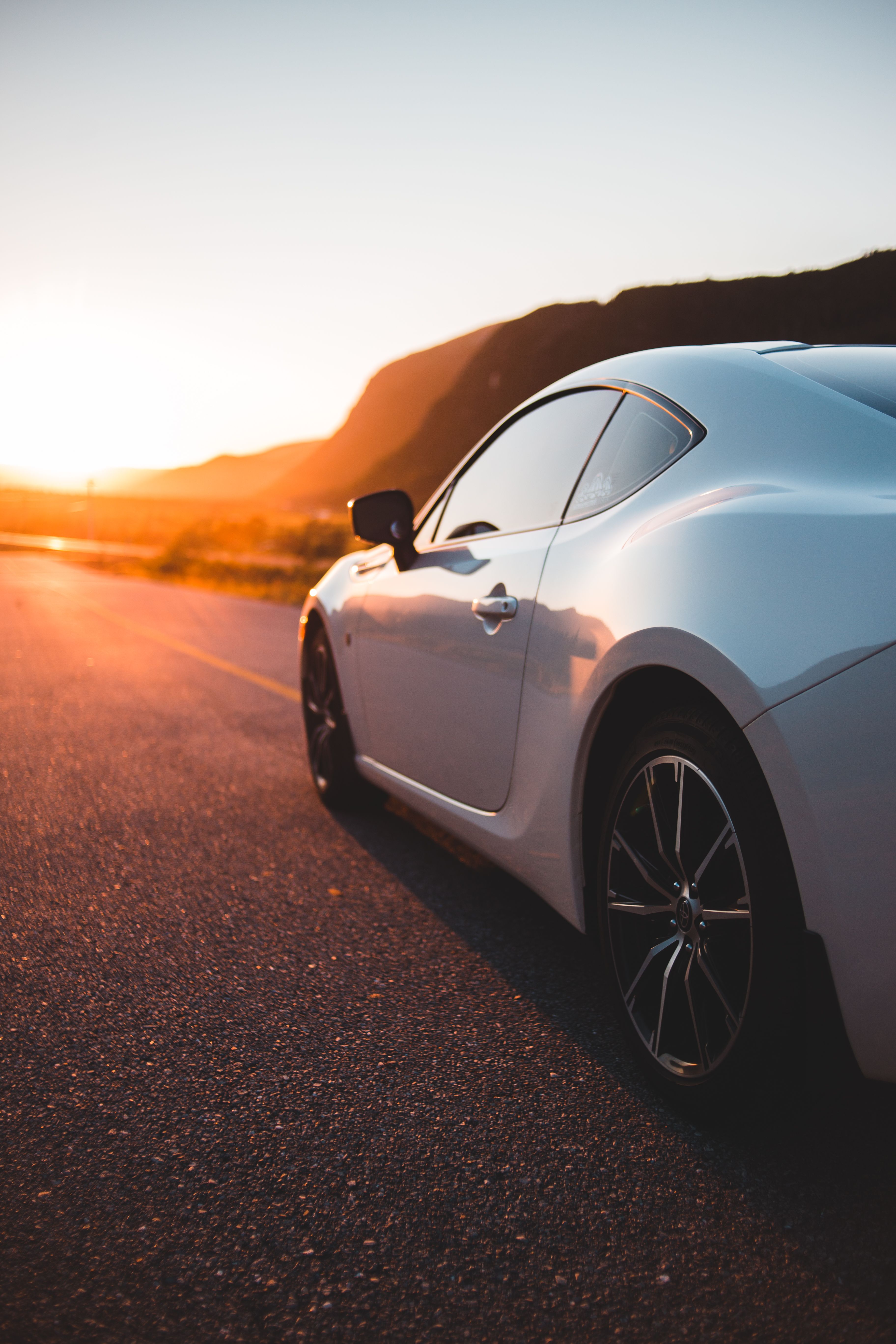 A Black Car Driving During Golden Hour · Free Stock Photo