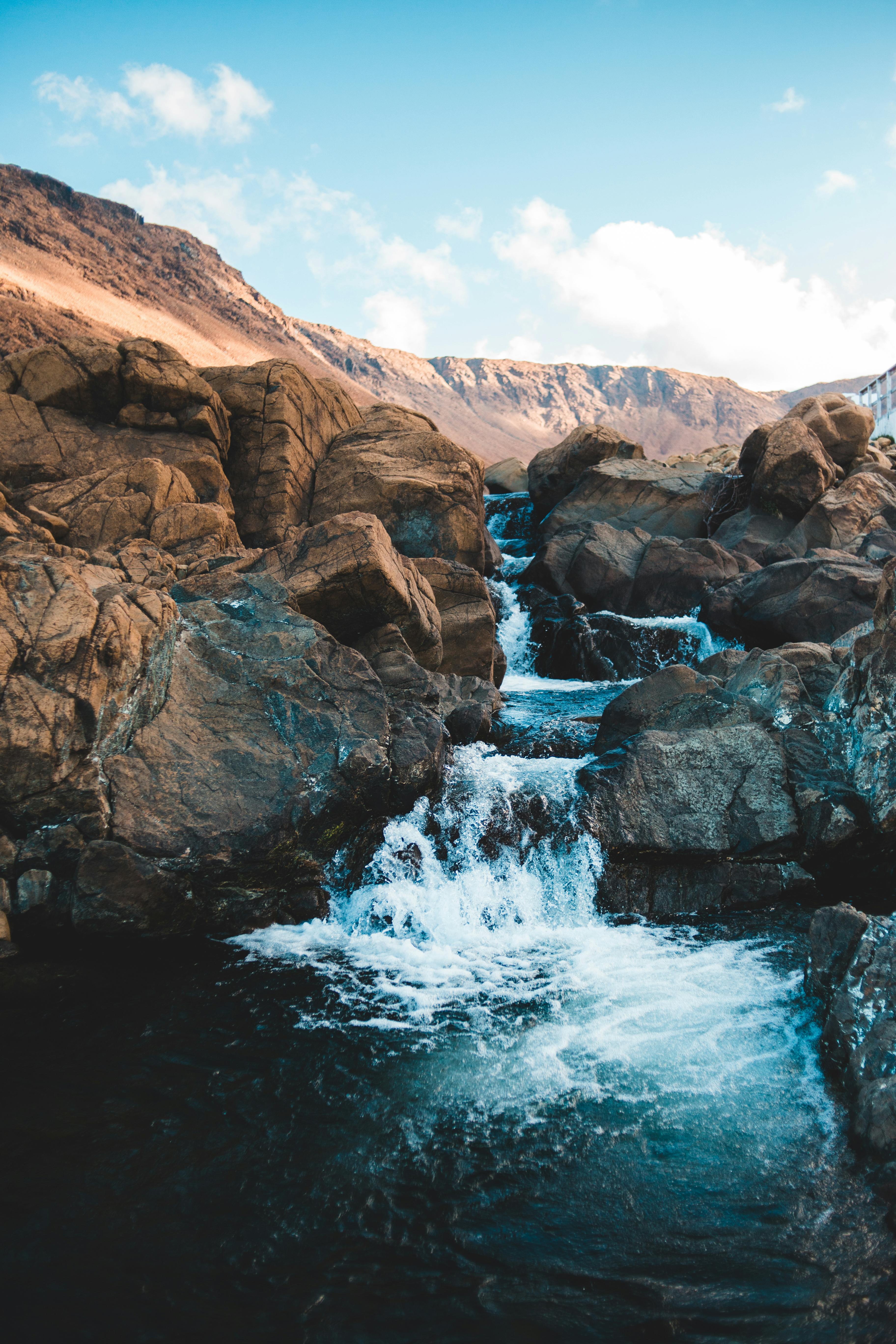 Waterfall flowing through rocky ravine · Free Stock Photo