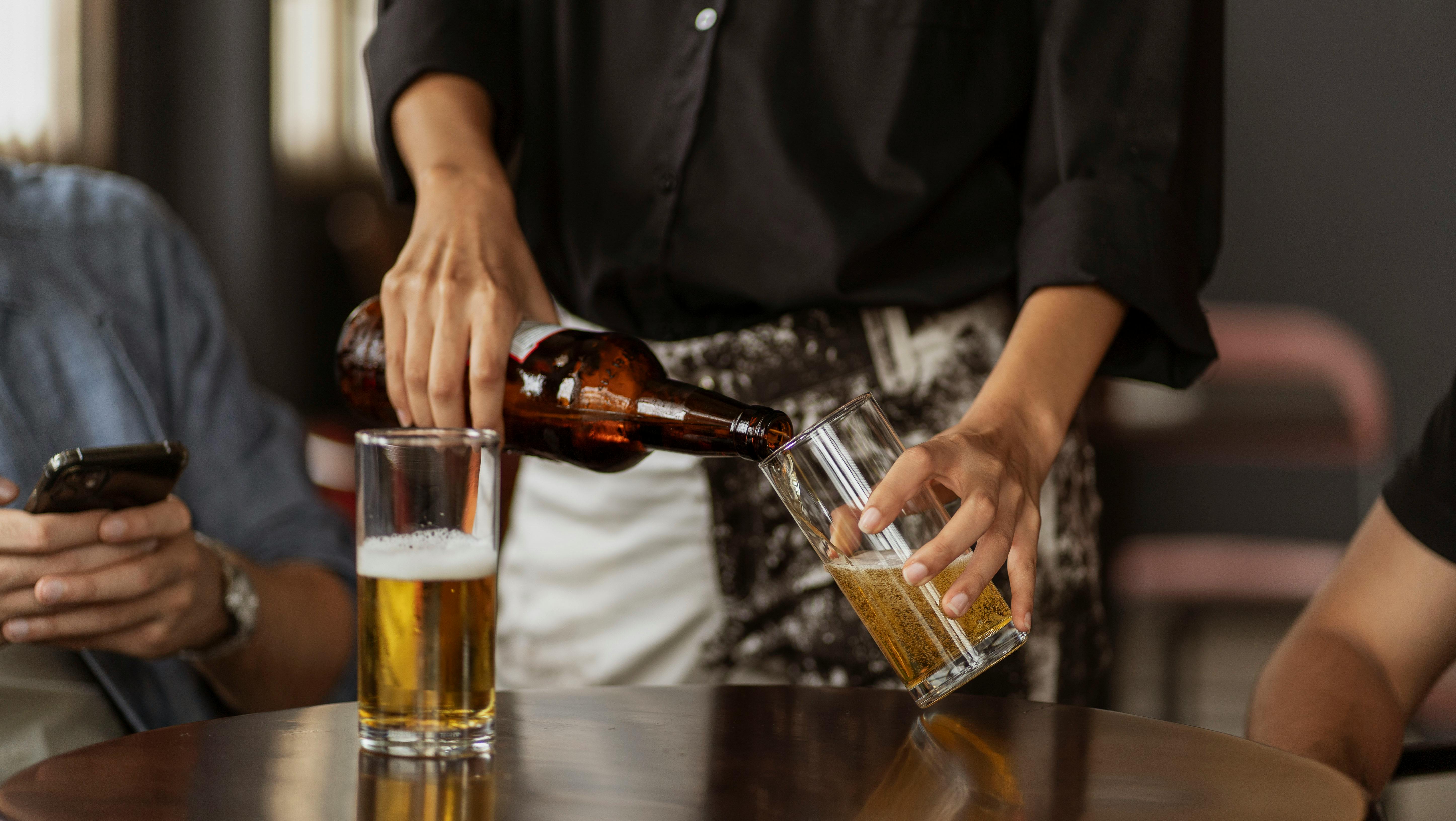 Waitress Filling Up the Glass with Beer · Free Stock Photo