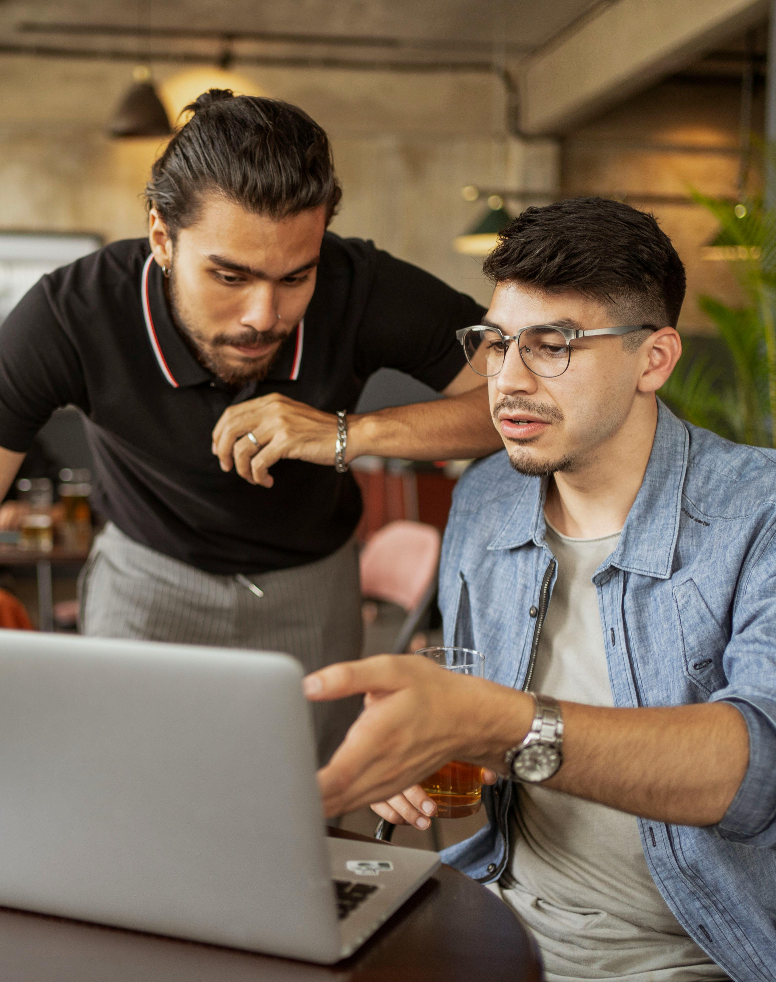 Two Men Looking at a Laptop · Free Stock Photo
